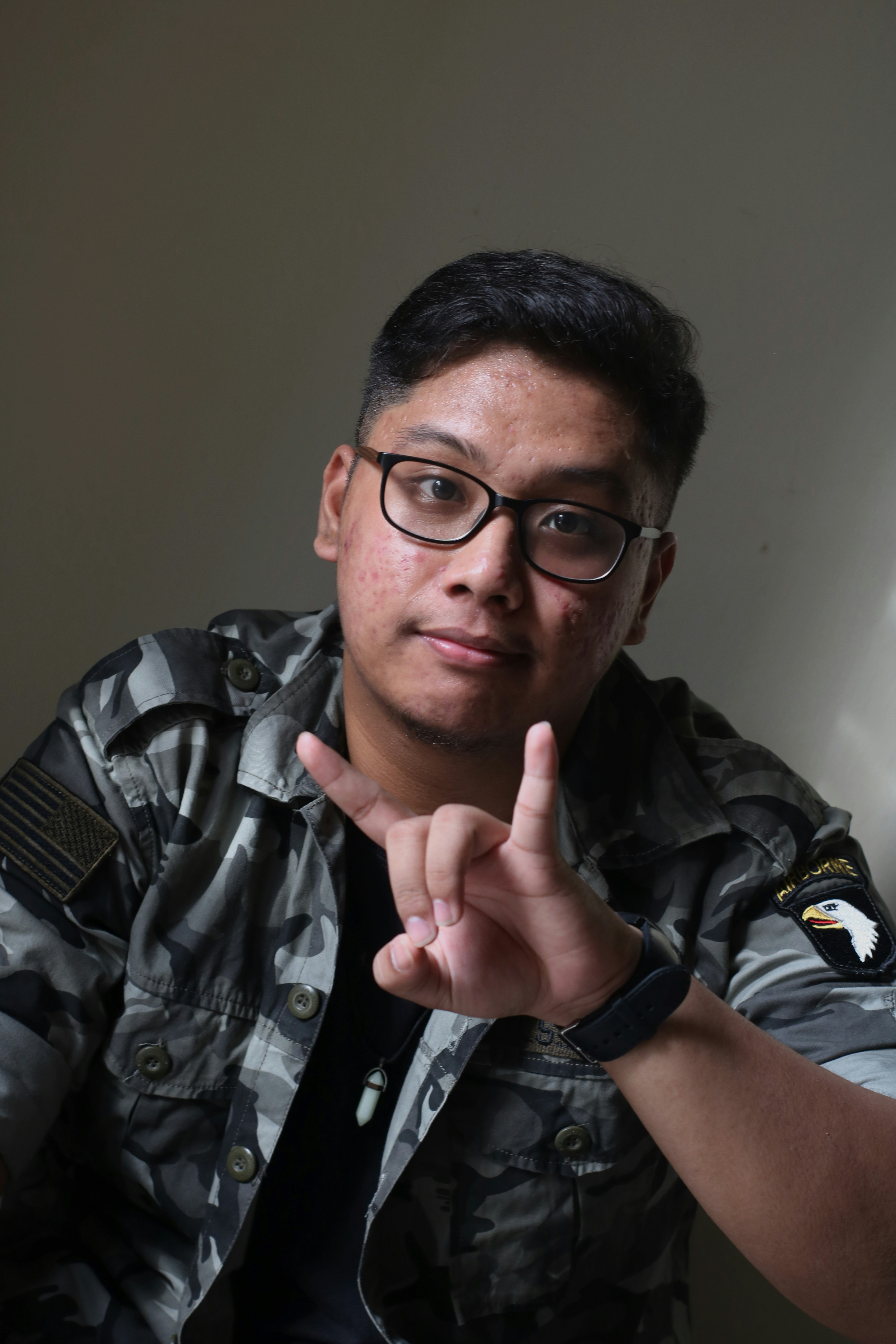 A man in a military uniform pointing at something photo – Free Black ...