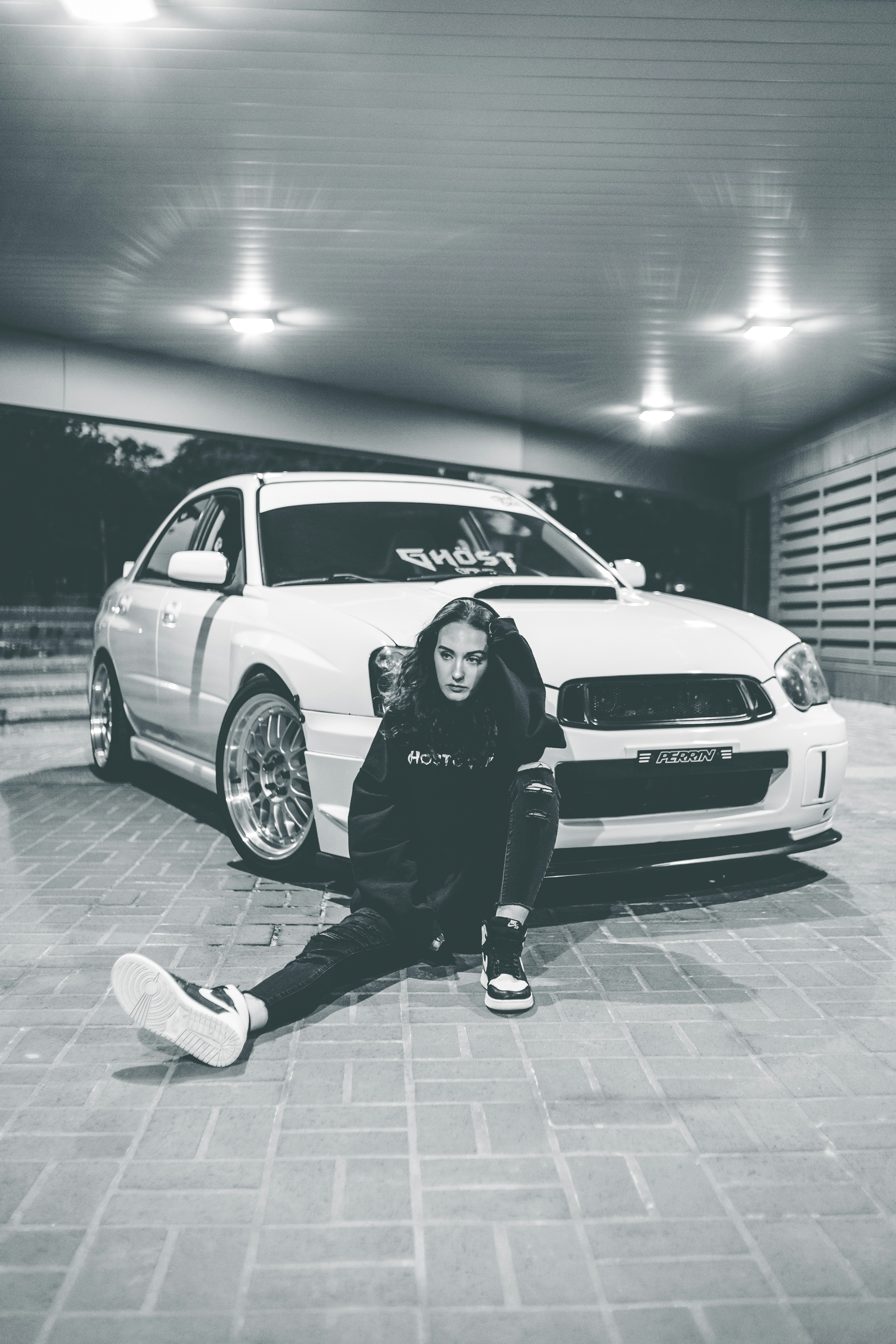 Urban Night Drive: Quiet Confidence by the White Sedan