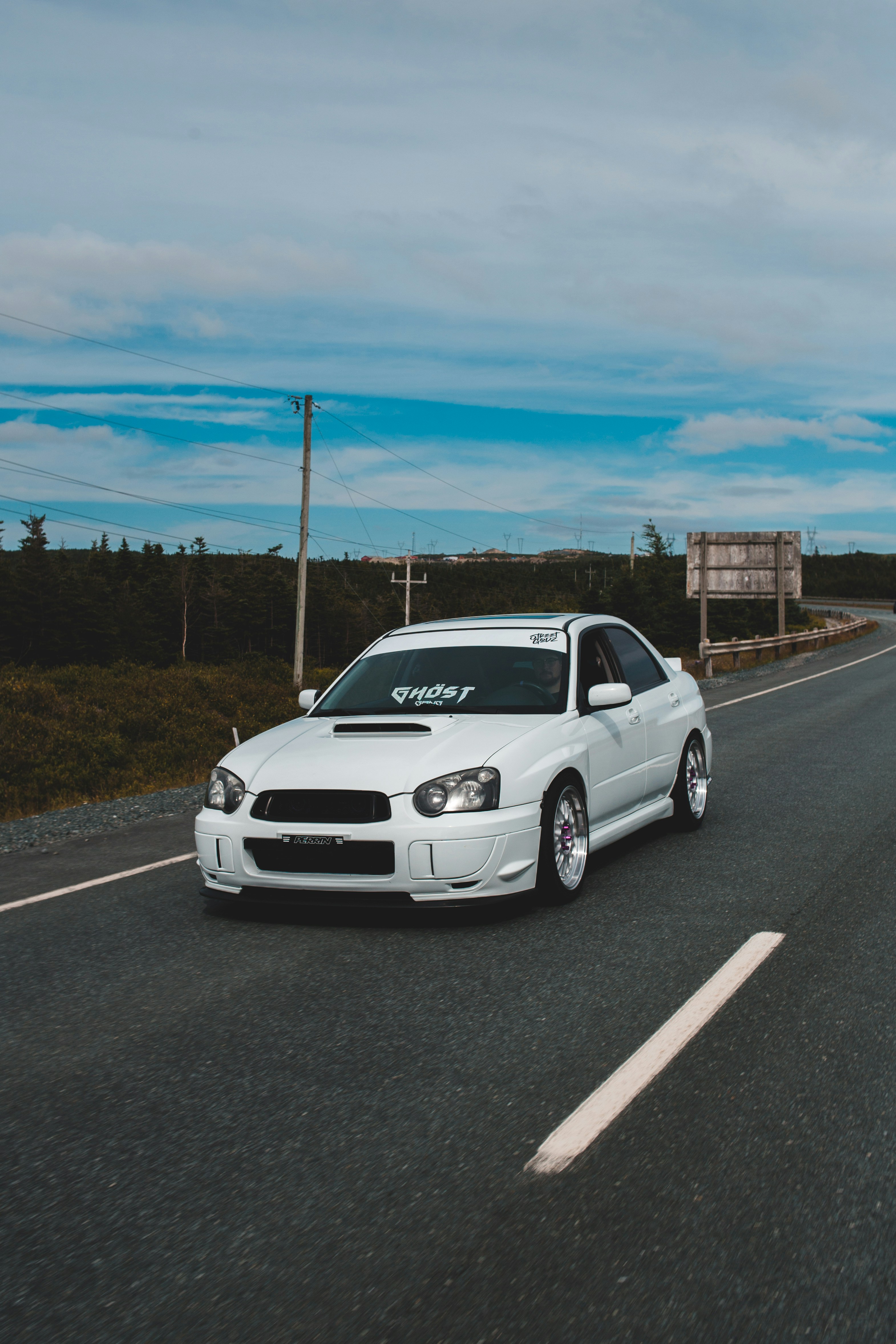 white honda sedan on road during daytime