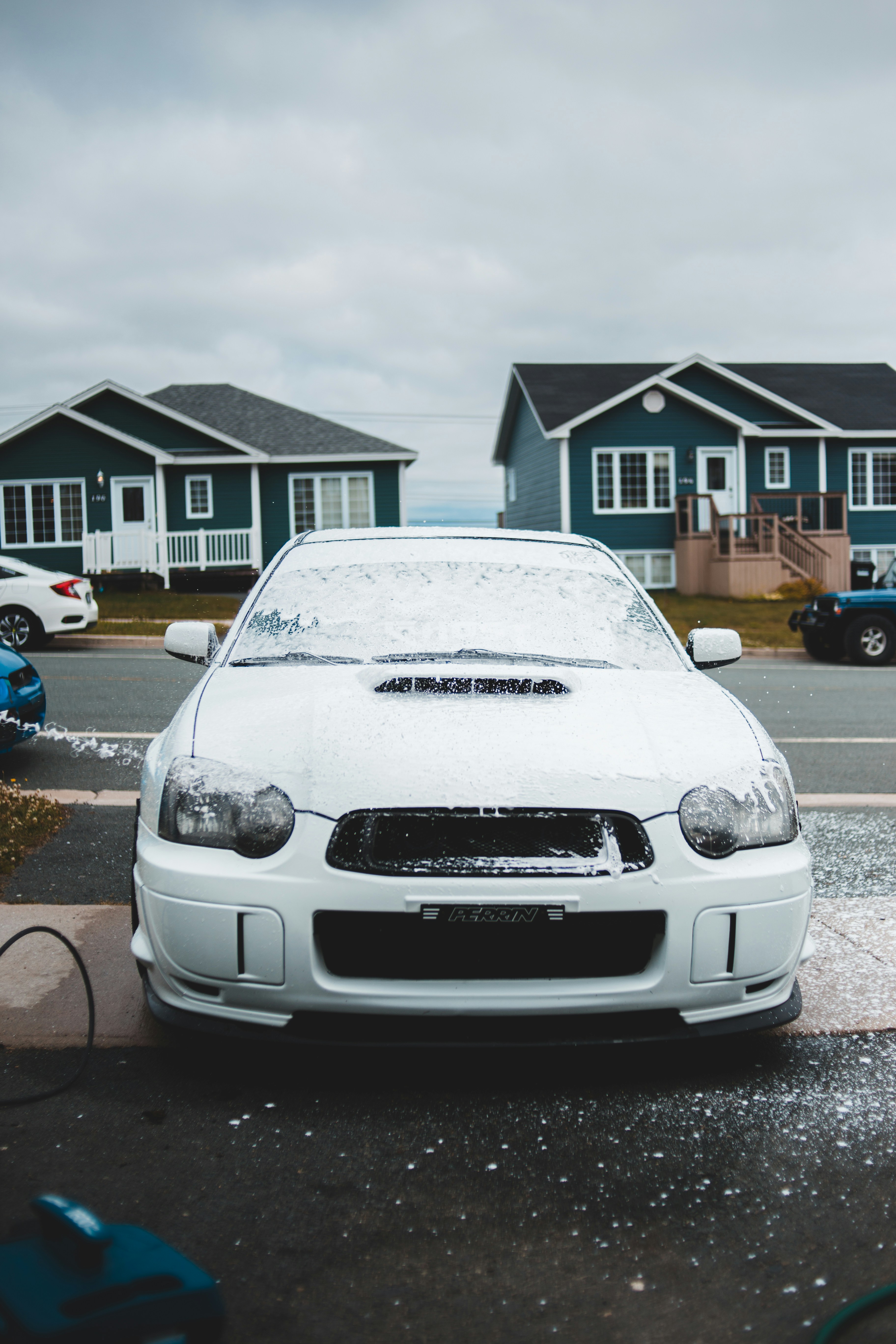 White Suburban Sprinter Under a Cloudy Crest
