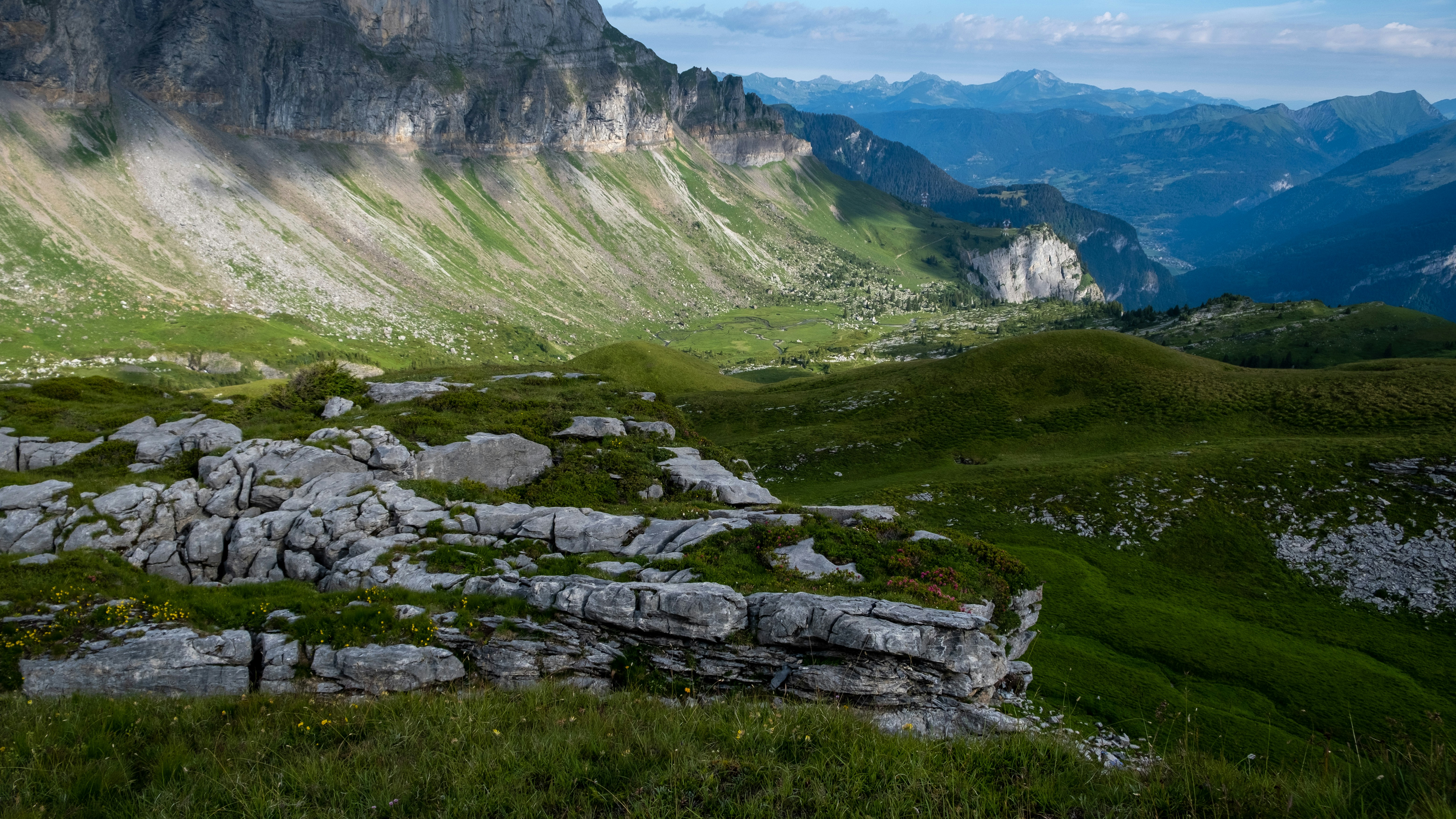 Green grass field and gray rocky mountain during daytime photo – Free ...