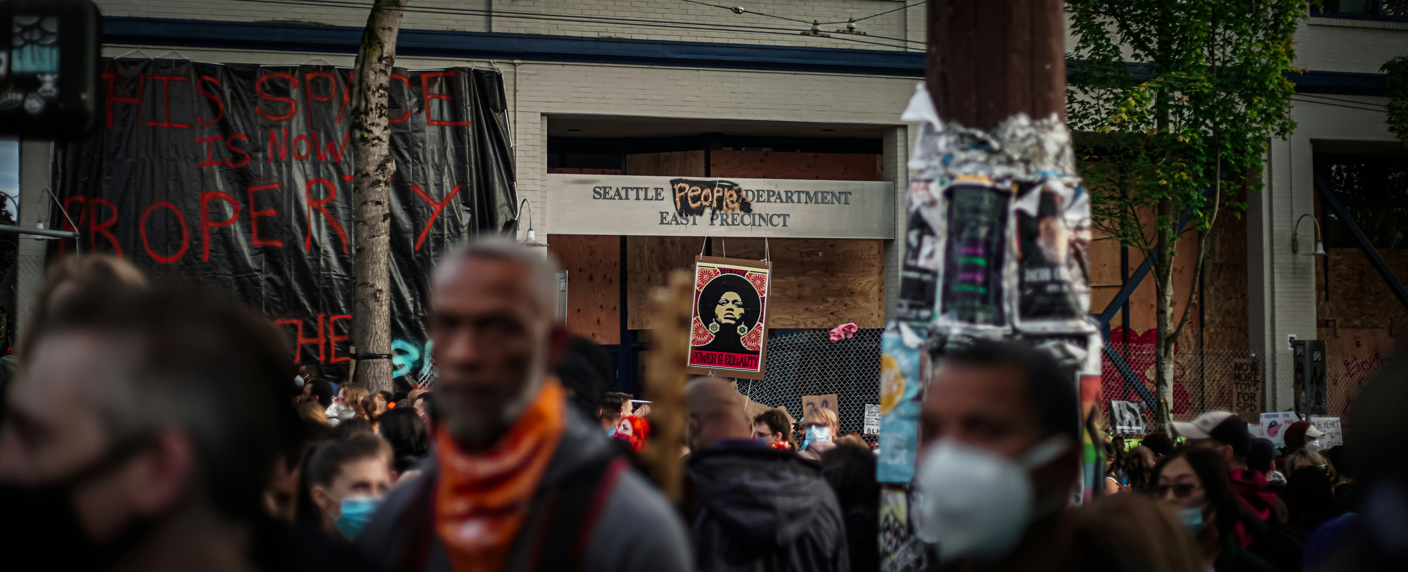 Framed Portrait Anchoring a Seattle Protest Amid the Crowd