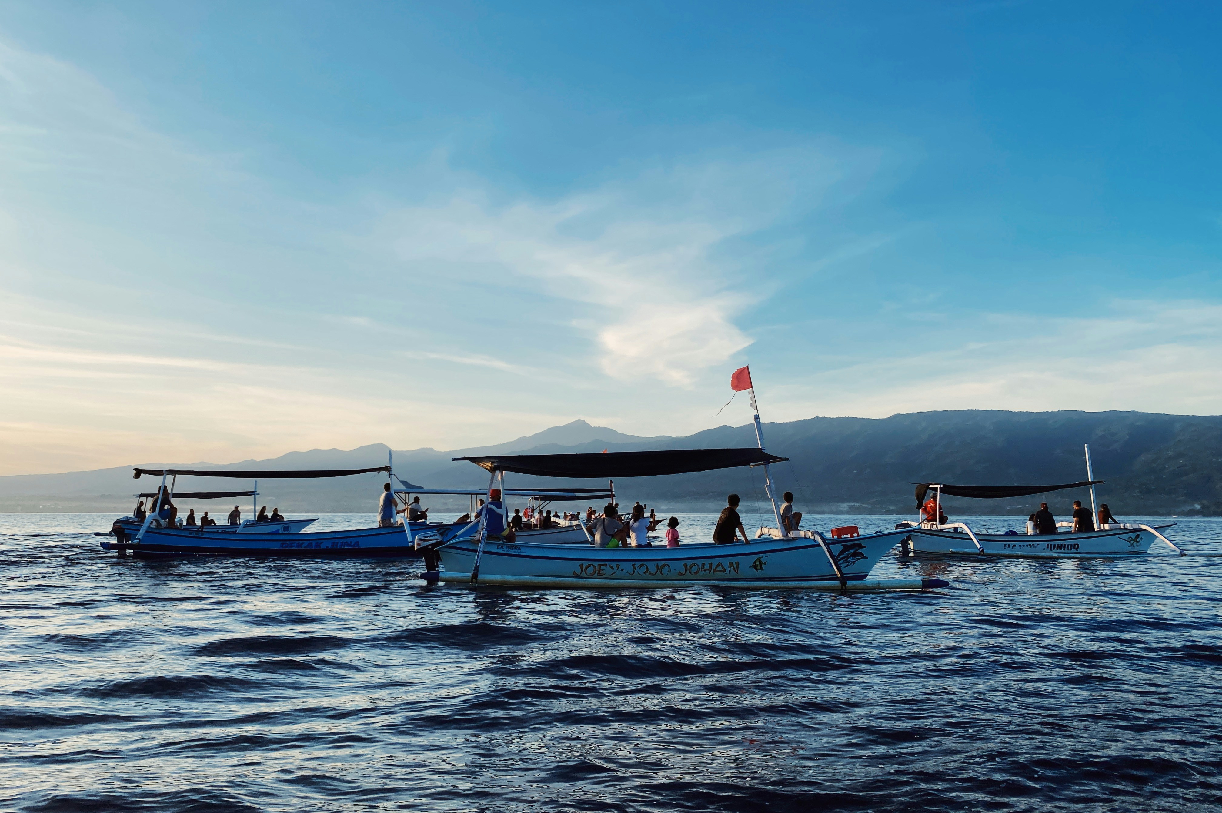 Flotilla Across a Glassy Sea Beneath a Pale Horizon