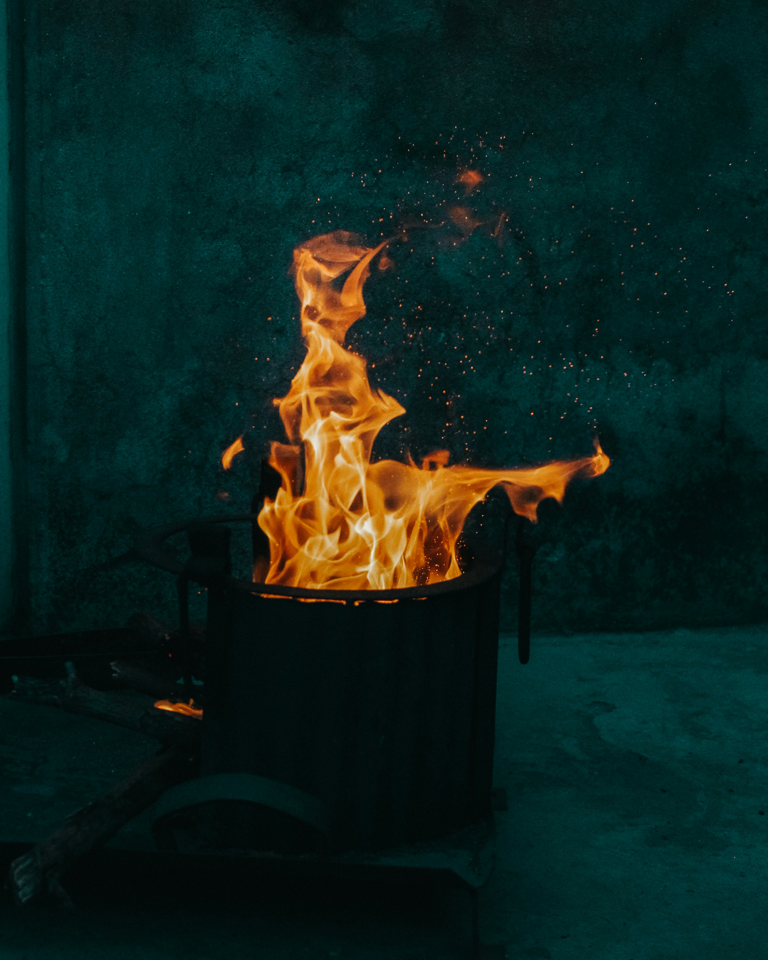 Ember Portrait in a Barrel: Quiet Inferno Against Teal Night