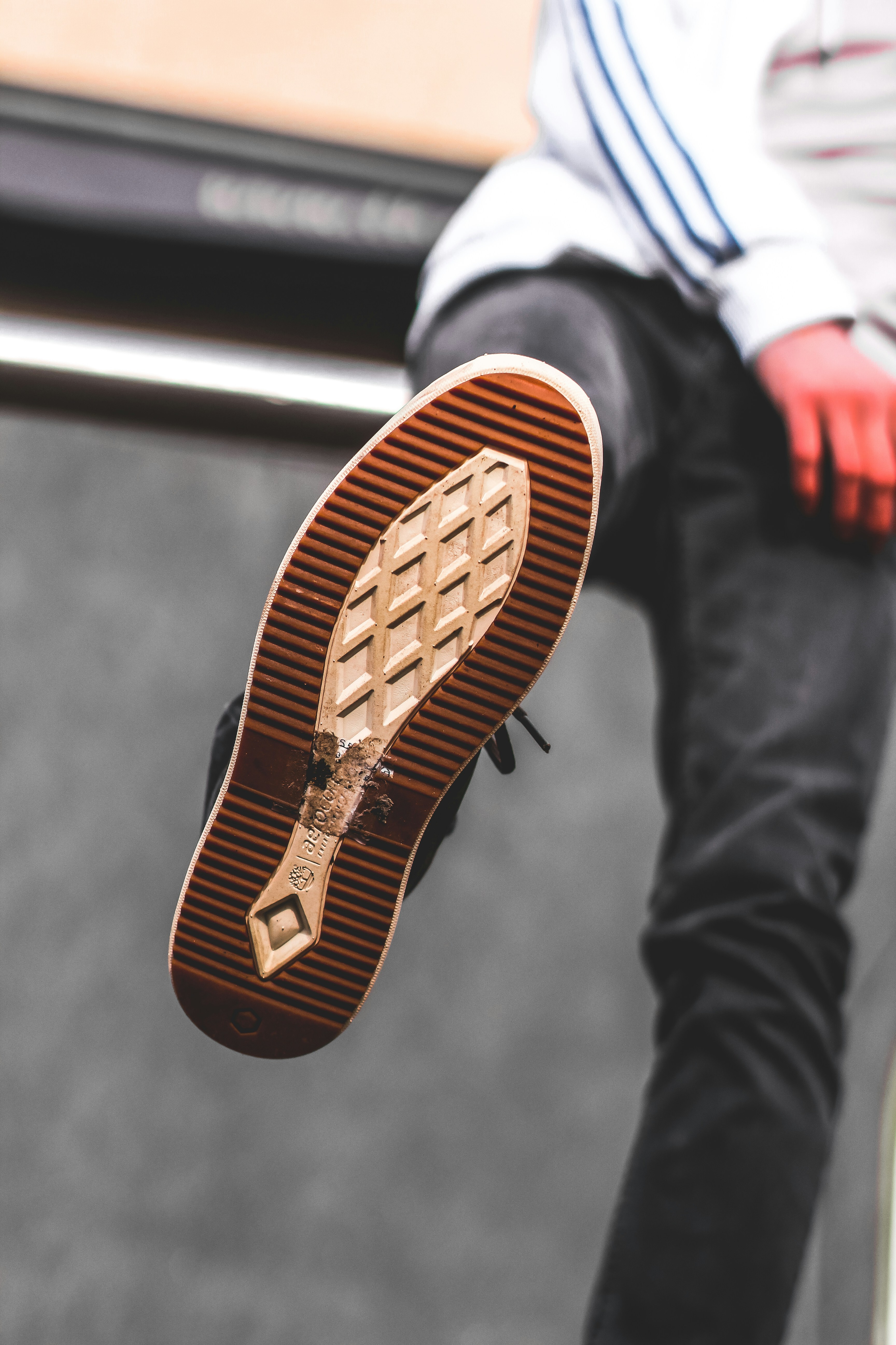 Forward Kick: Diamond-Tread Sole Piercing a City Blur