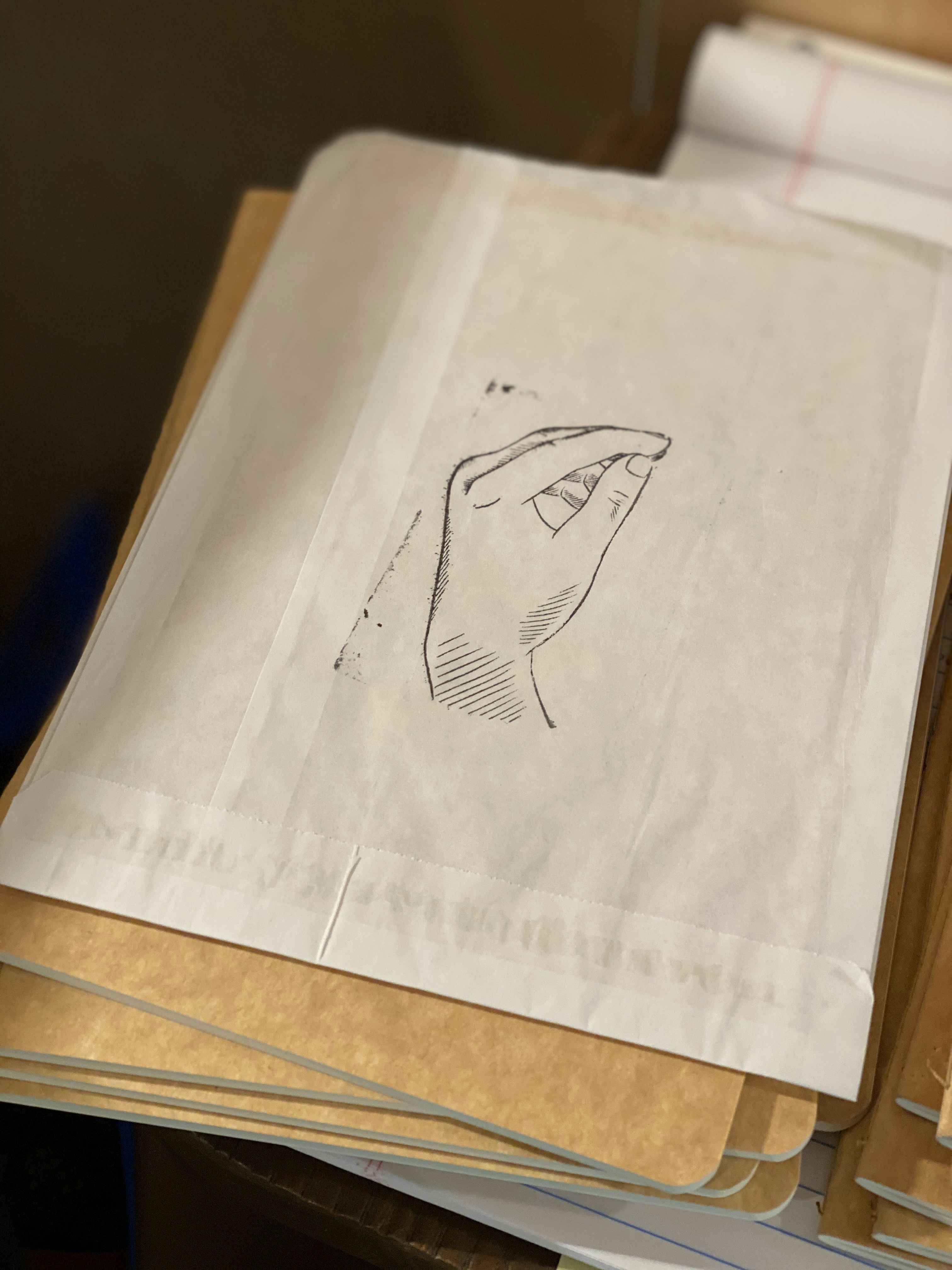 Ink on Tissue: A Quiet Hand Sketch Among Kraft Envelopes