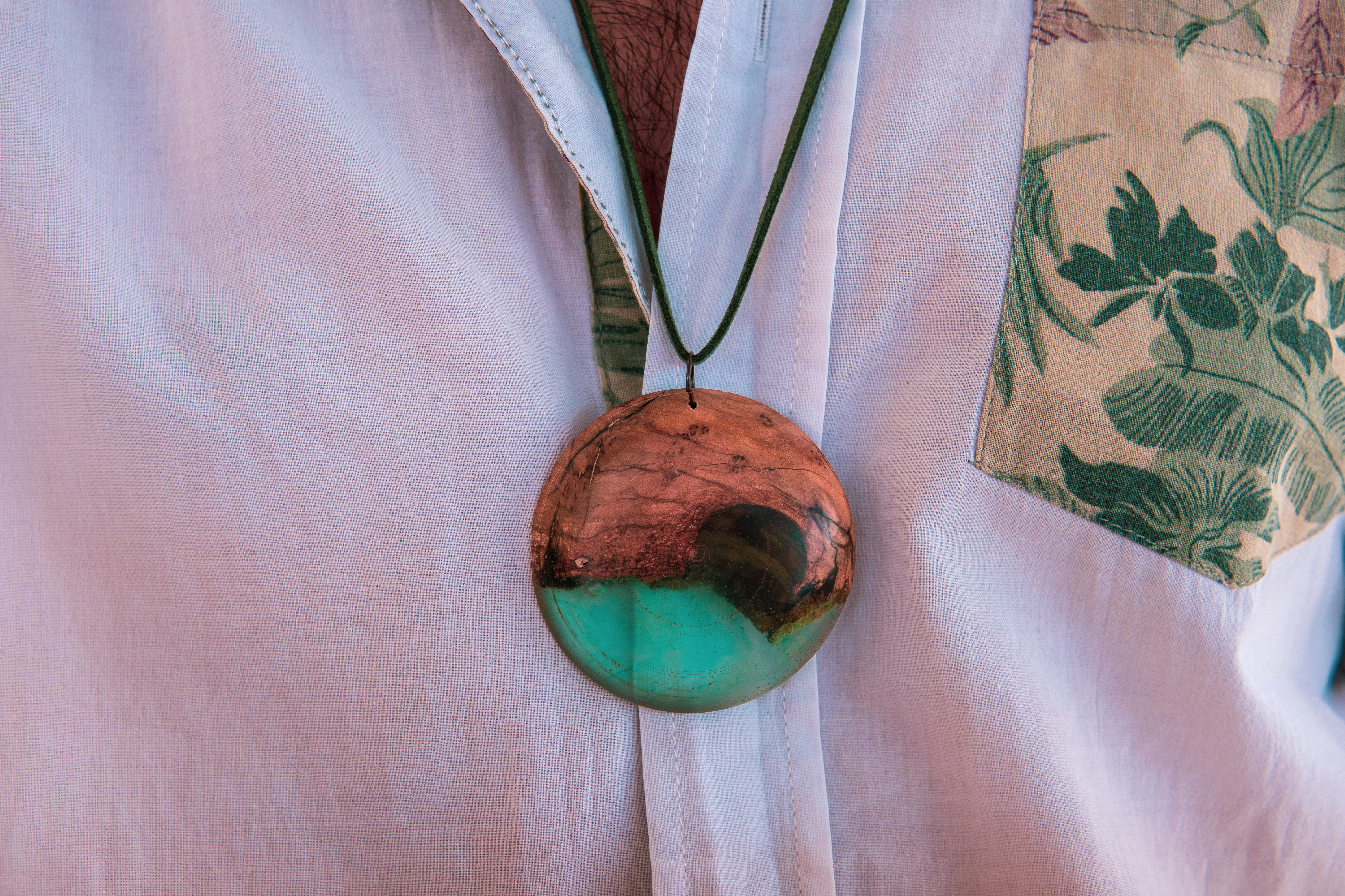 Green-and-Ceramic Pendant on White Shirt