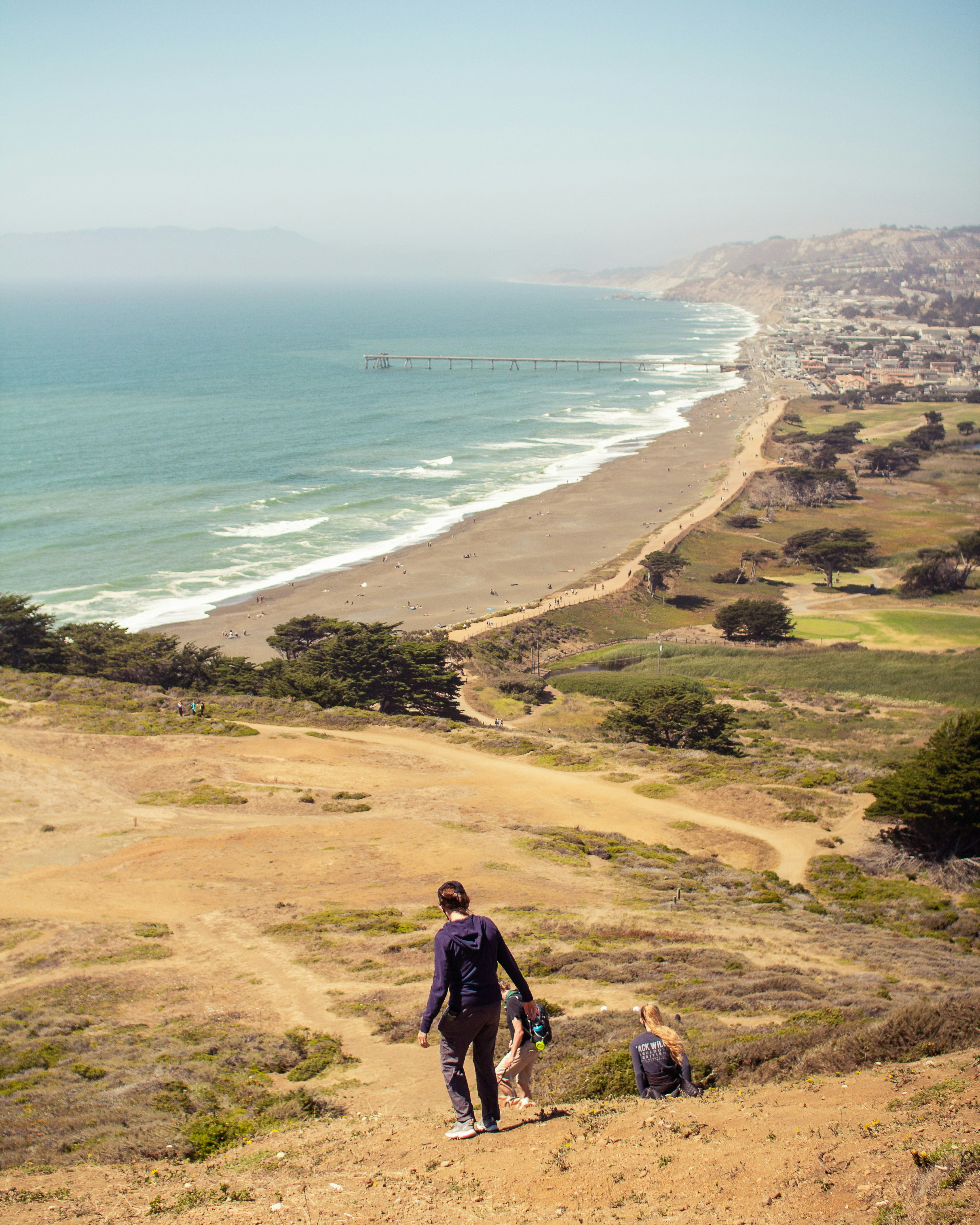 Hikers' Ascent Along Coastal Serenity