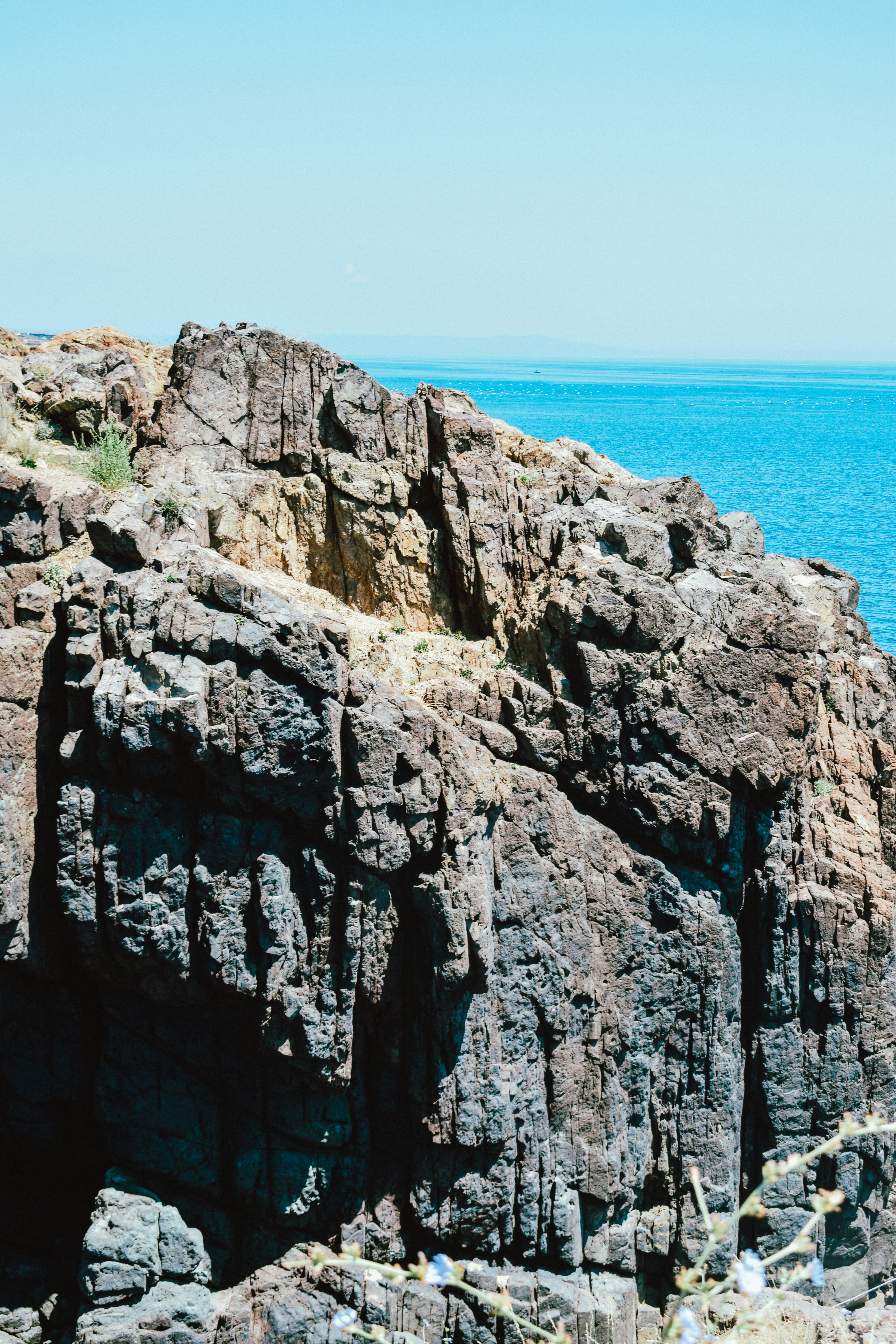 Gray rocky mountain near blue sea during daytime photo – Free Nature ...