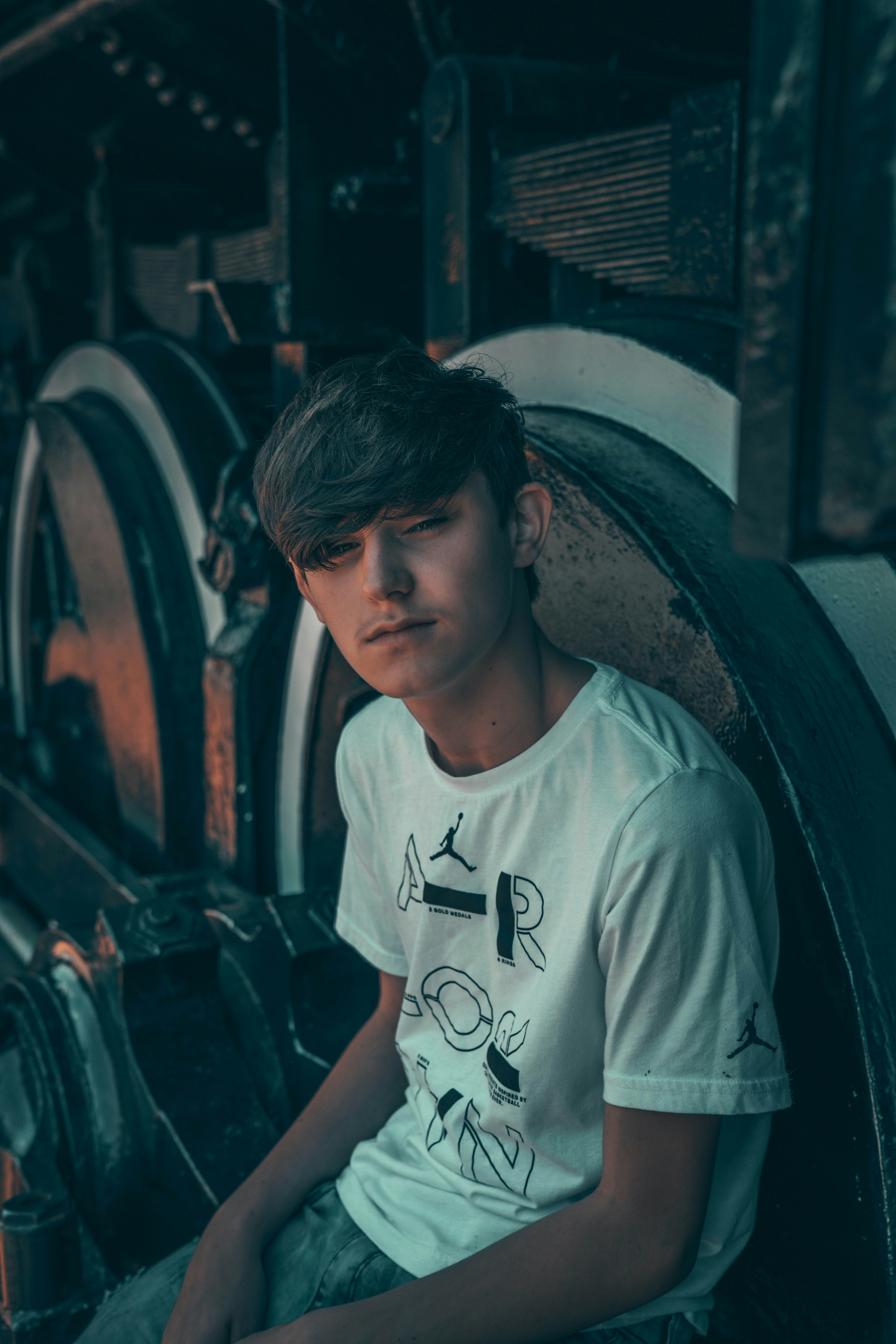 Portrait in an Industrial Frame: Youthful Gaze by Weathered Machinery