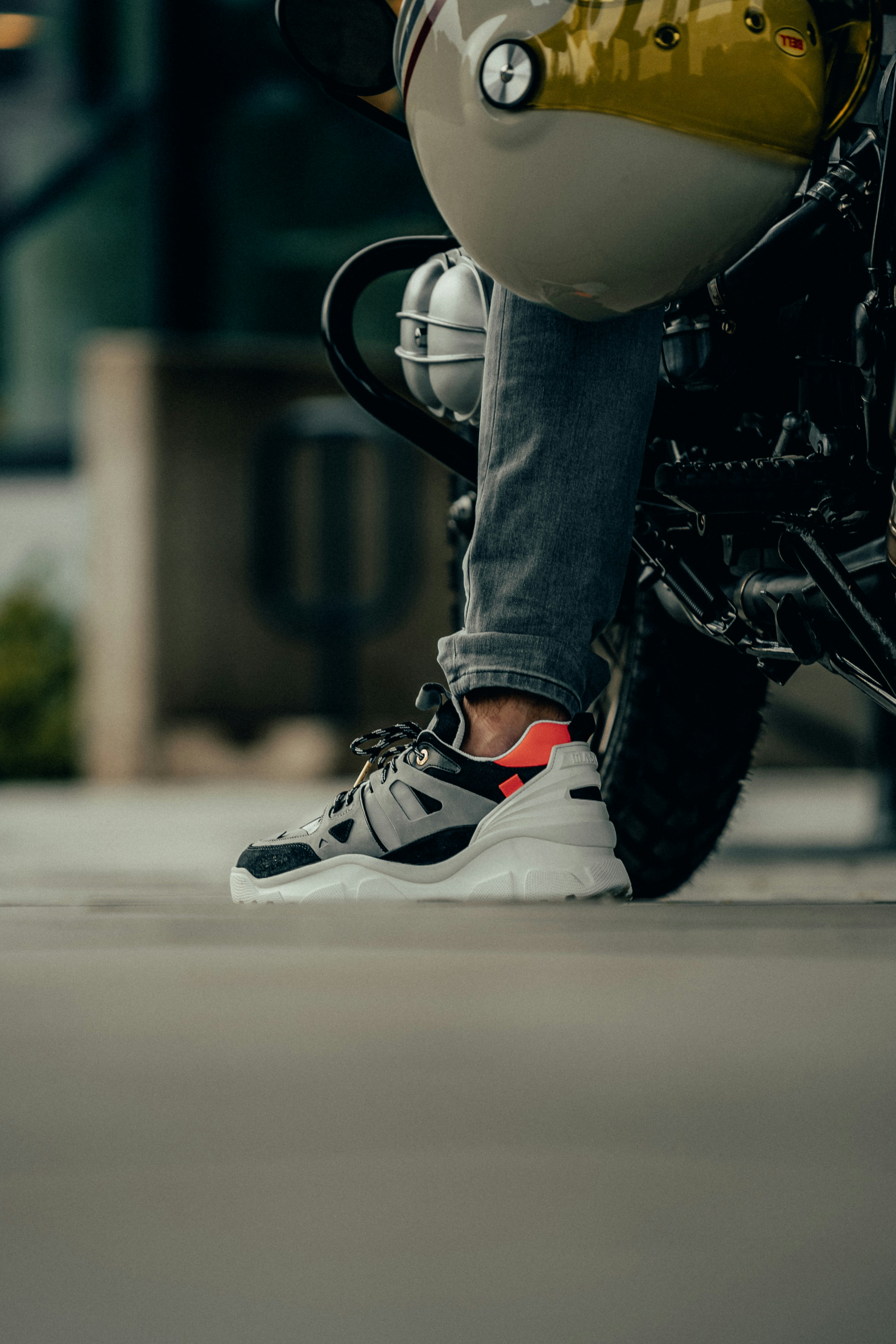 Midnight Ride: A Sneak Portrait of Foot, Jeans, and Chrome