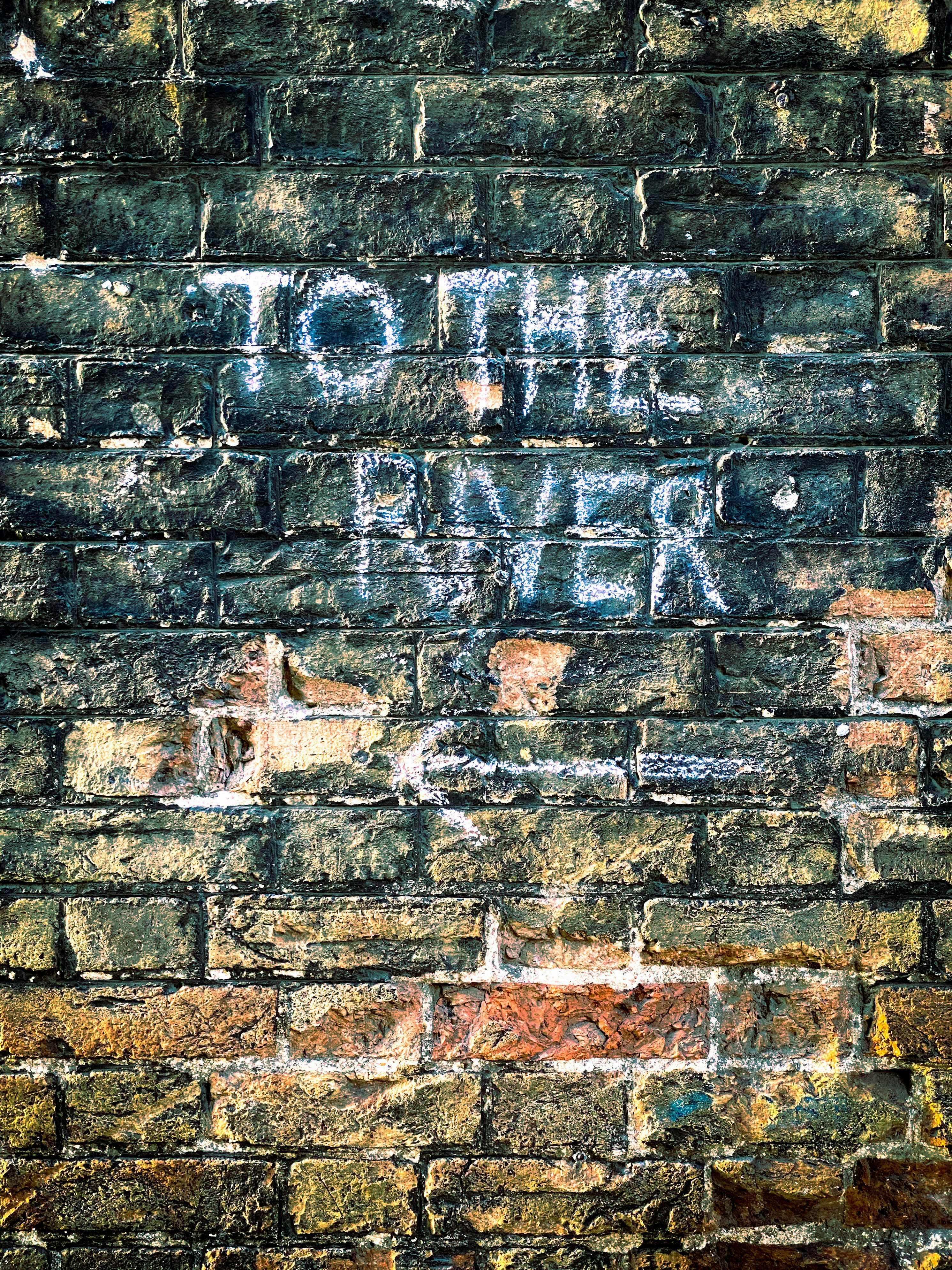 Chalked Message on a Weathered Brick Wall
