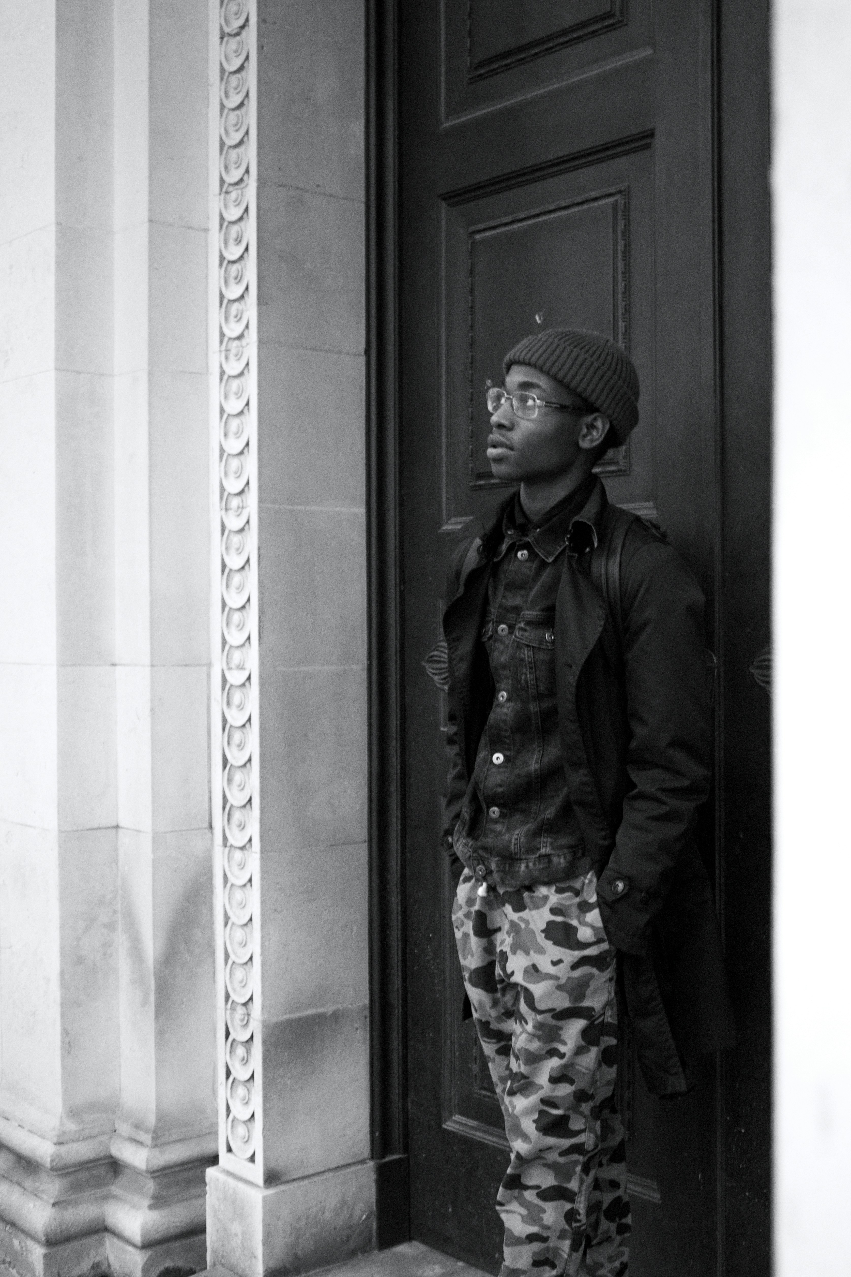 Portrait in Silence: A contemplative youth by a grand doorway