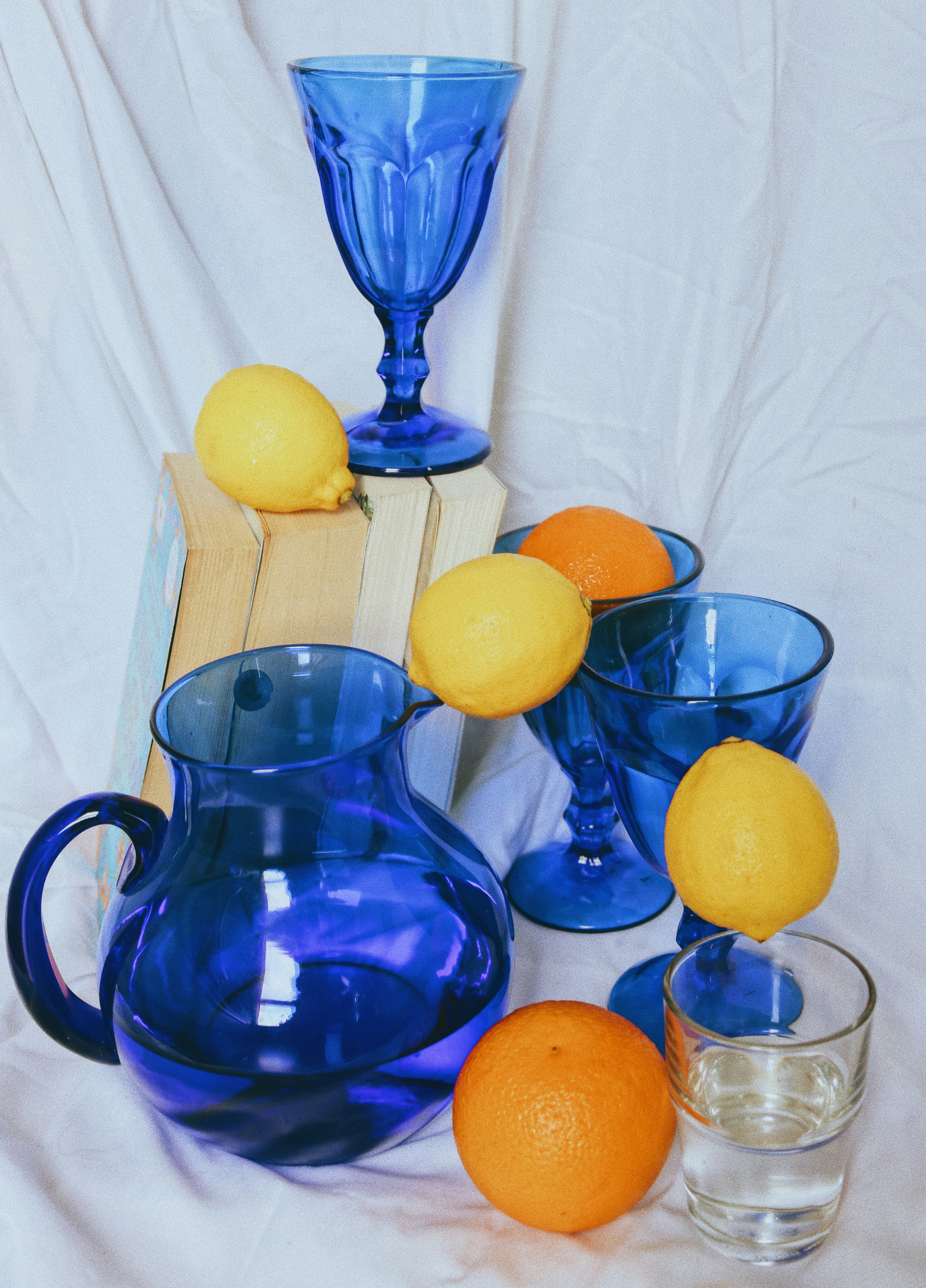 Blue glass pitcher with lemon fruits photo – Free Still Image on Unsplash