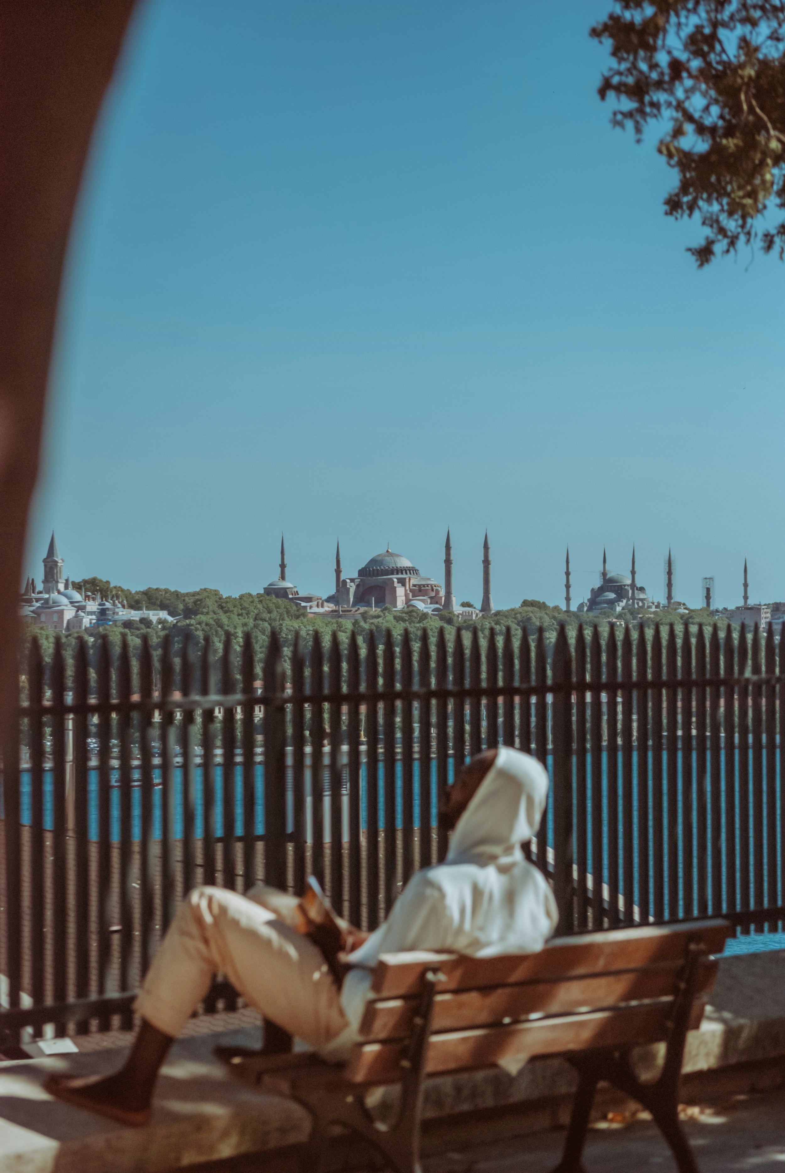 Relaxed Onlook: A Seated Traveler Overlooking the Bosphorus Skyline