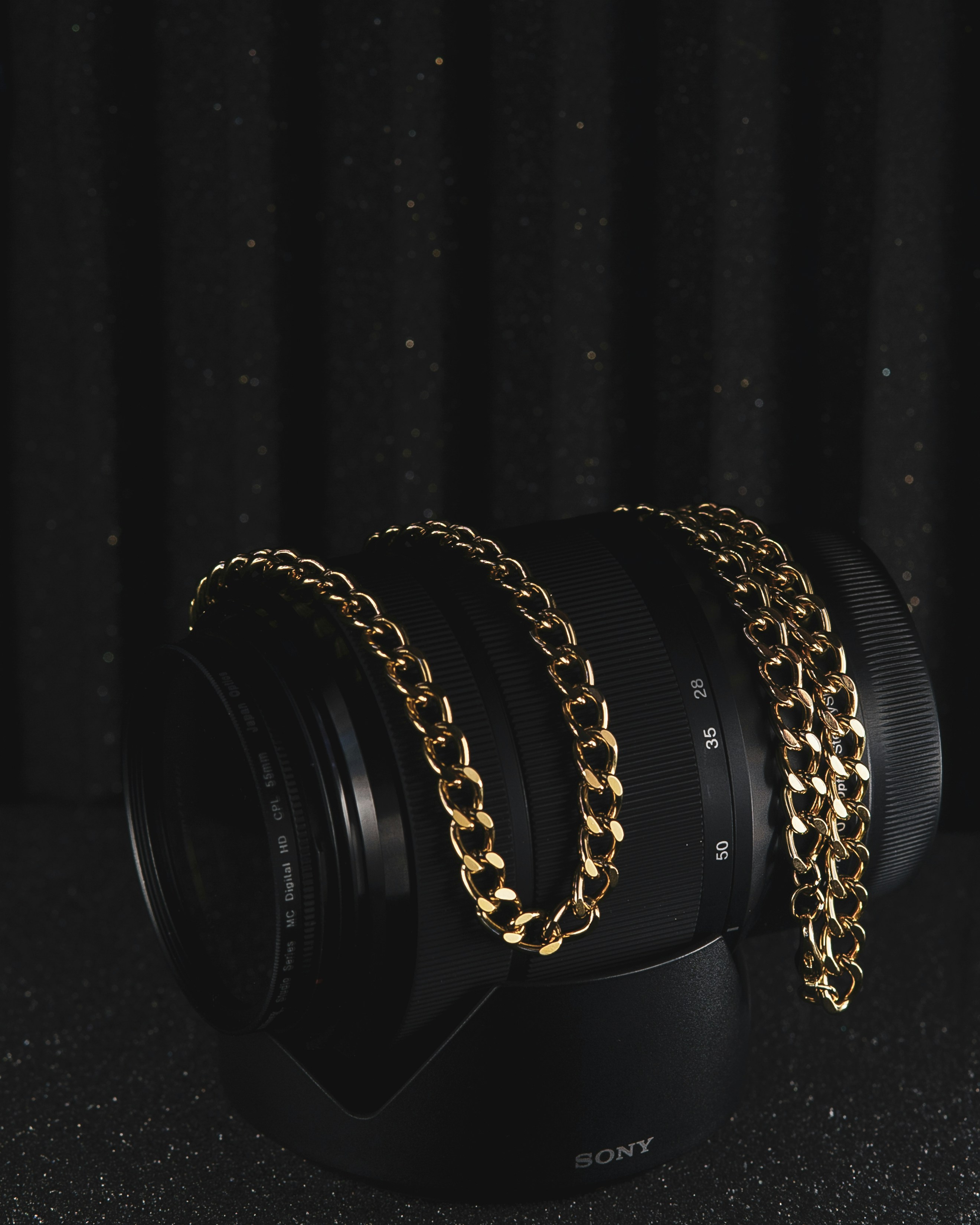 Gilded Chains Embrace a Midnight Lens