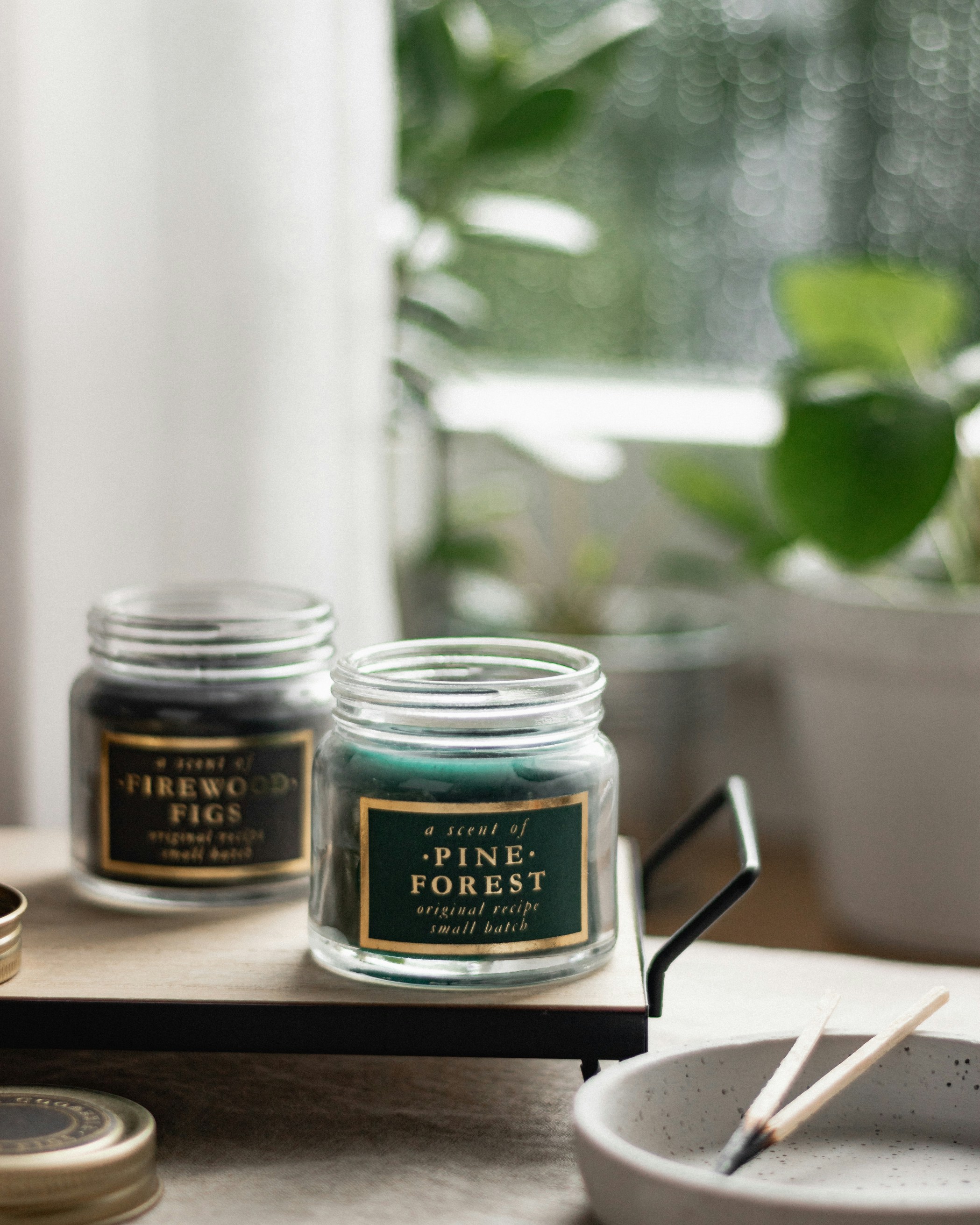 Teal Pine Forest Candle on a Wooden Tray: Quiet Still-Life in Soft Natural Light