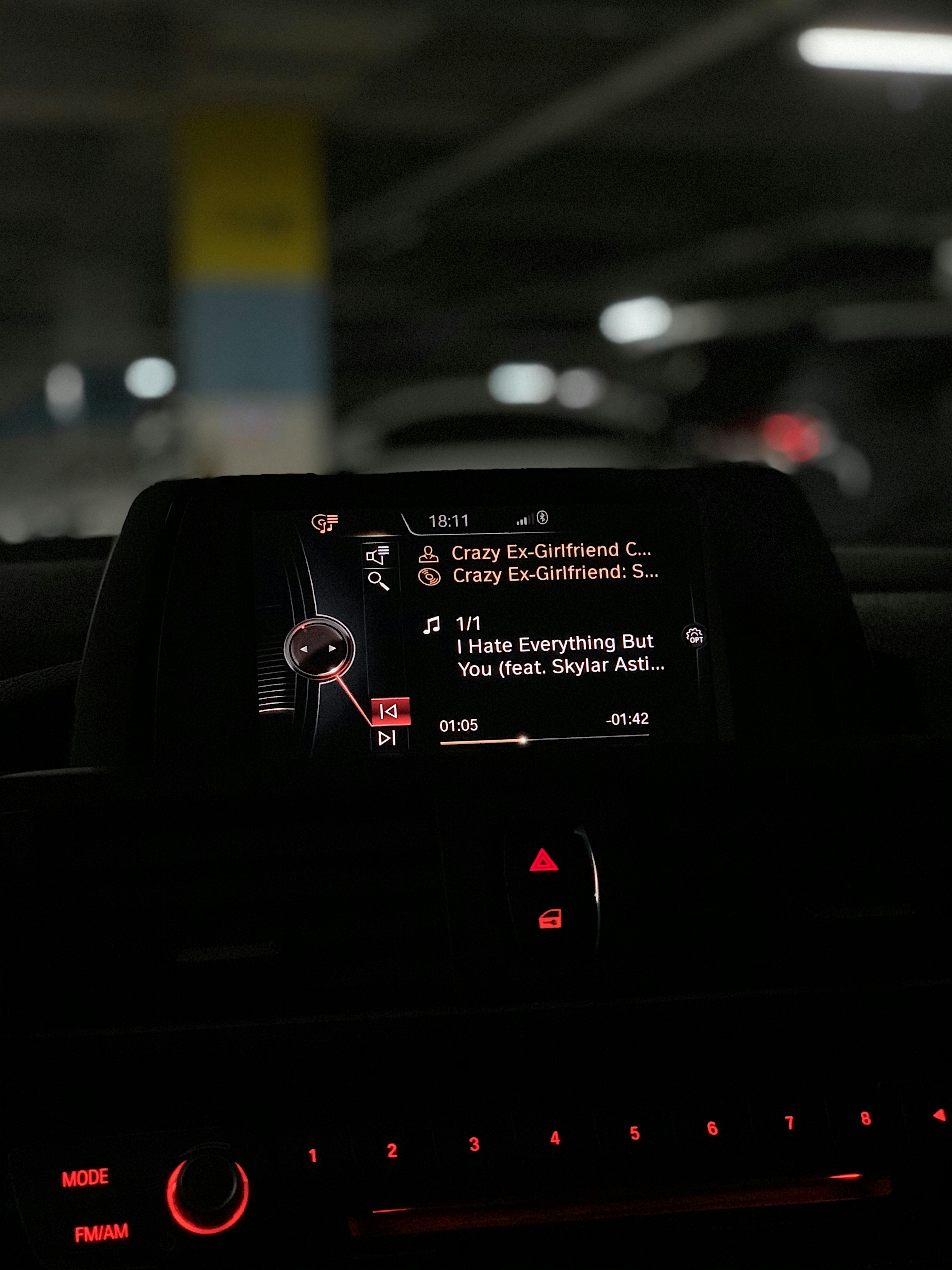 Midnight Glow on the Center Console: Infotainment Screen in a Dim Parking Garage