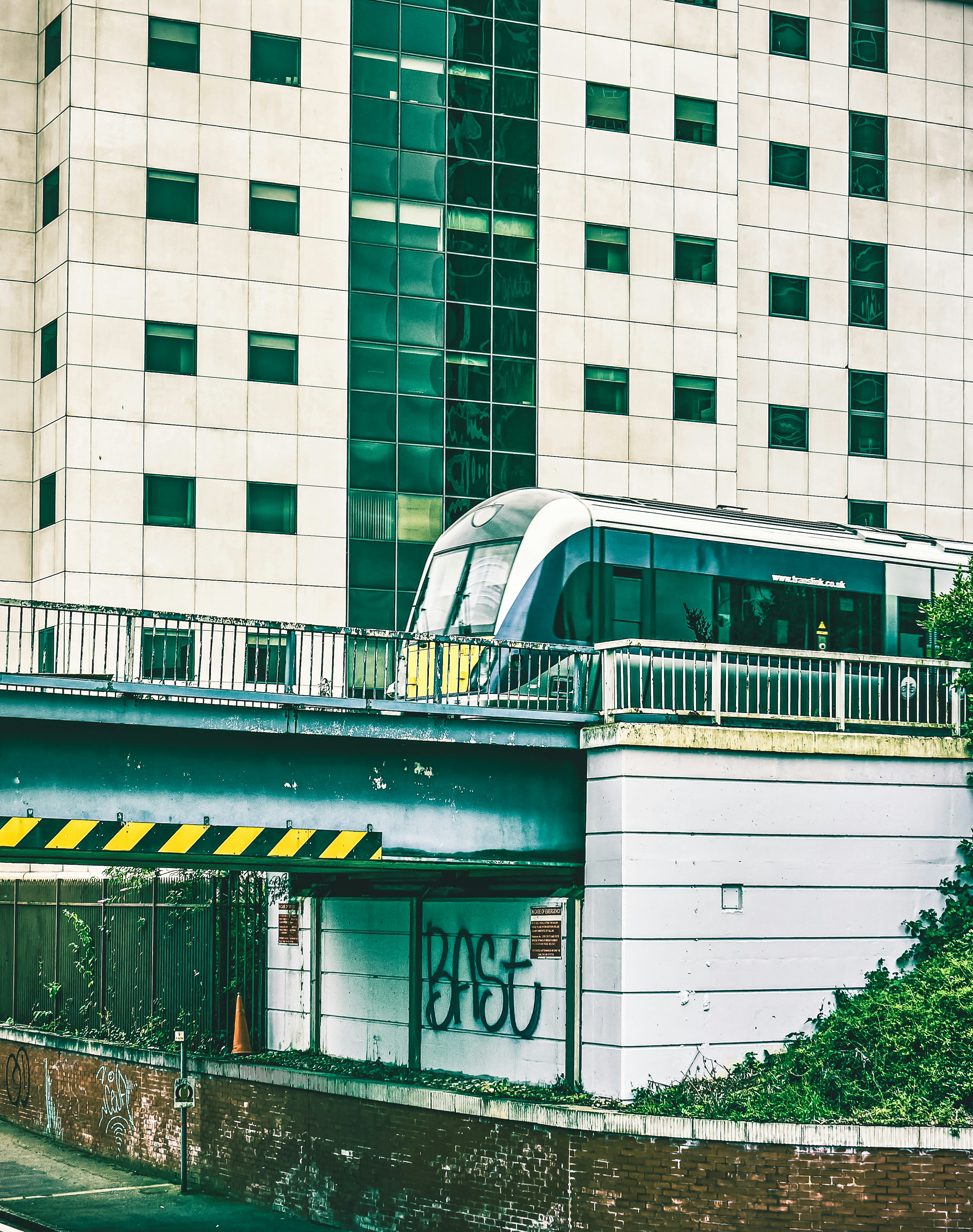 Elevated Tram on a Green-Glass City Ridge
