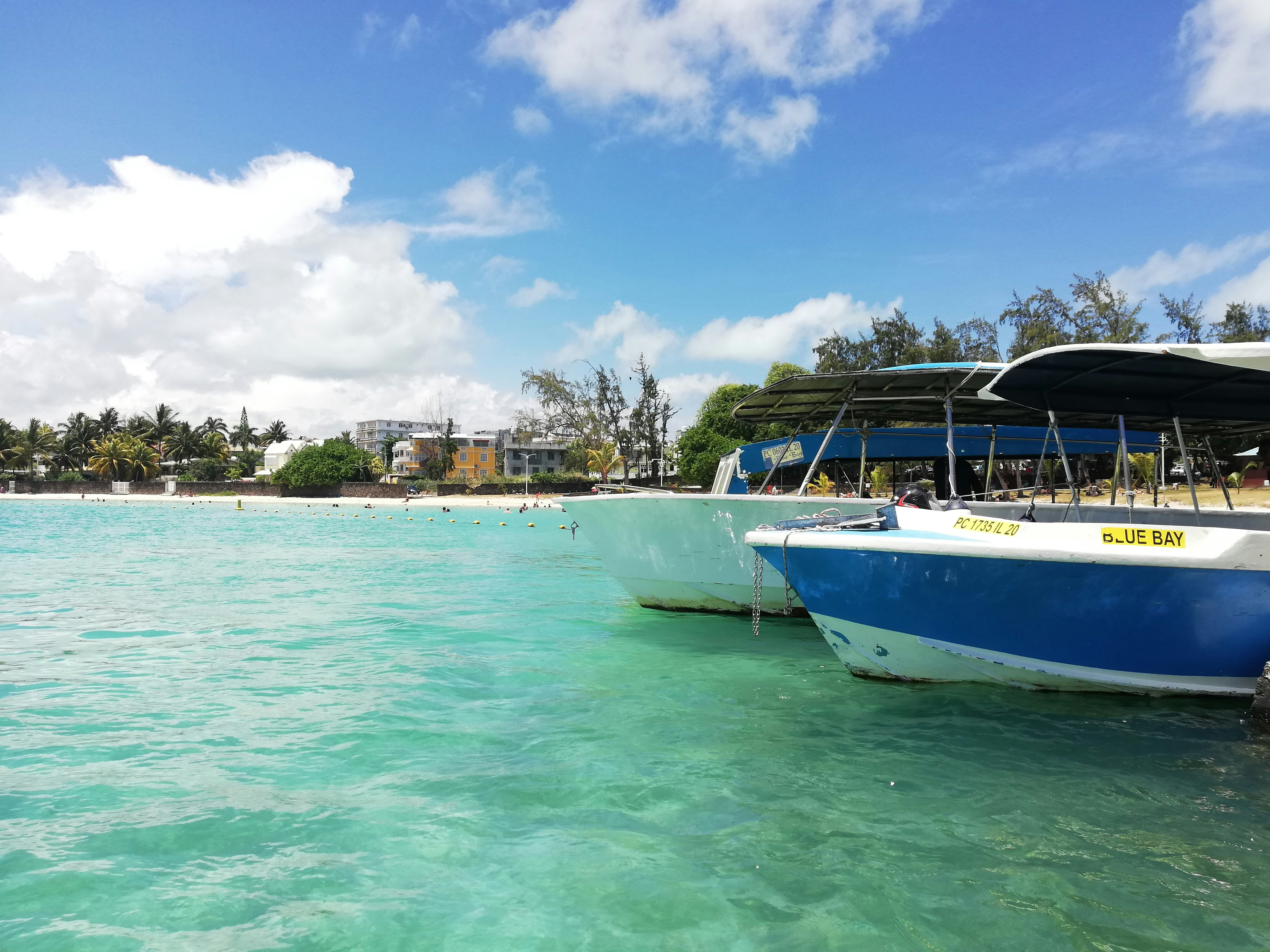 Turquoise Lagoon and Docked Boats at a Sunny Beach