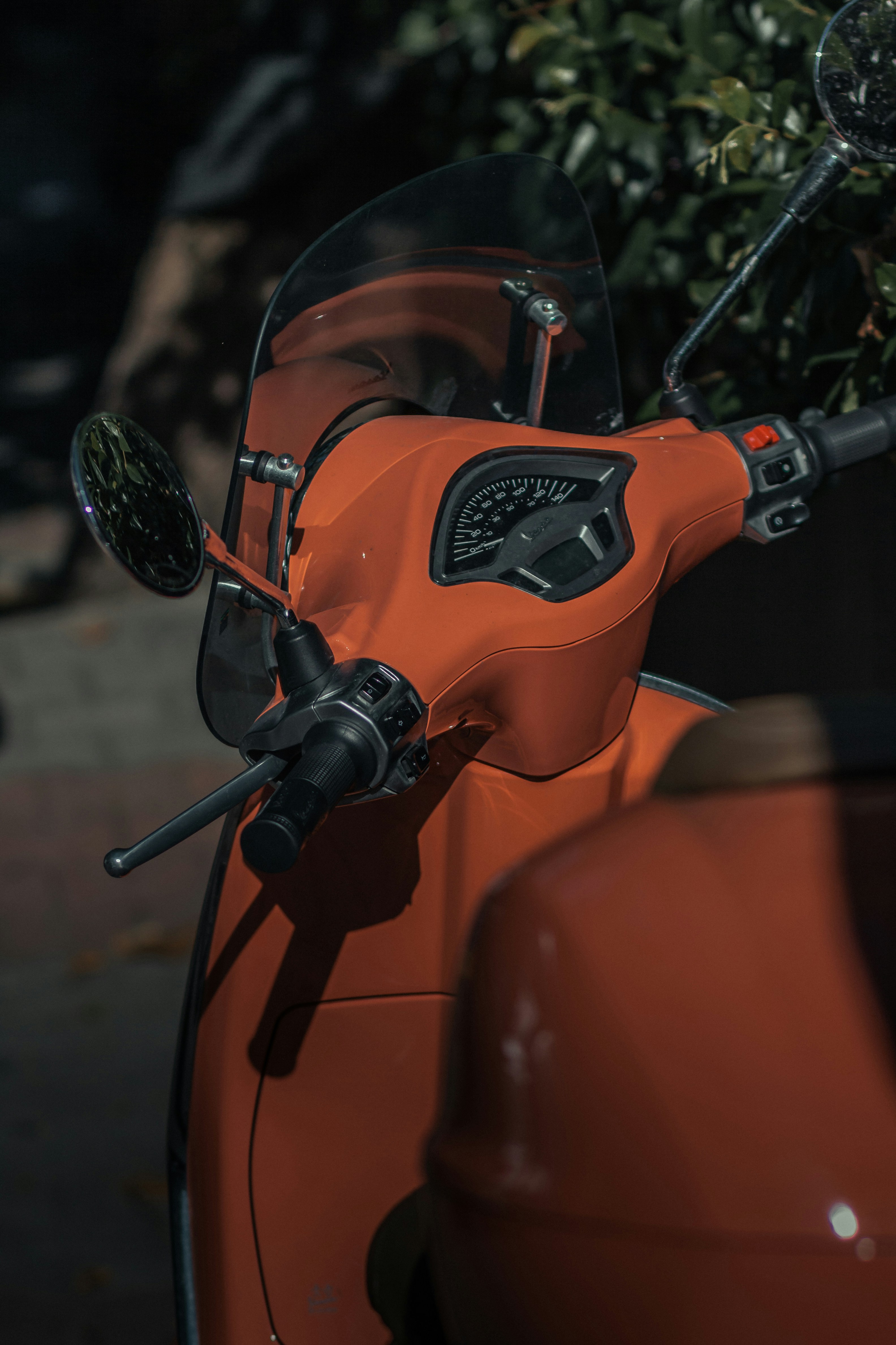 Orange Scooter Dash: The Handlebars and Console in Focus
