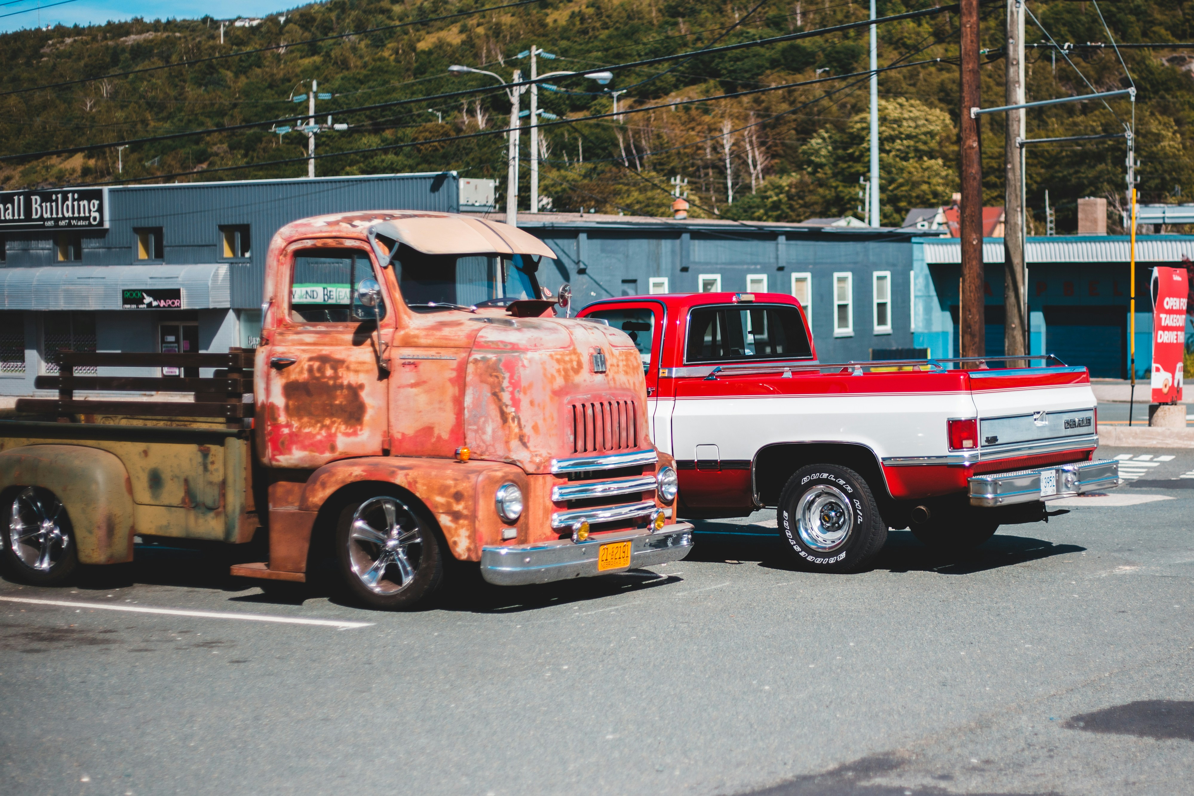 red and white truck on road during daytime