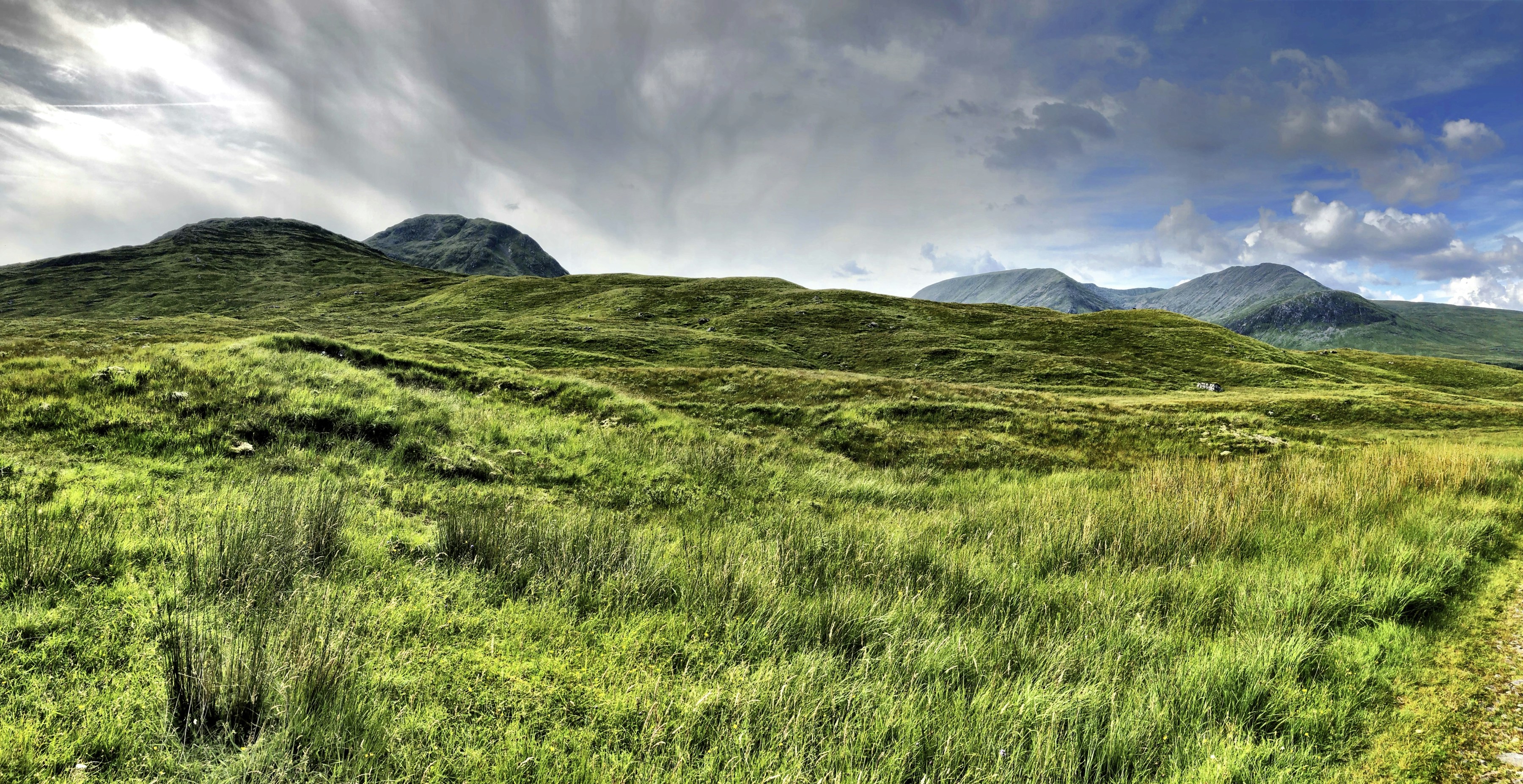 Verdant Hills Under a Moody Sky