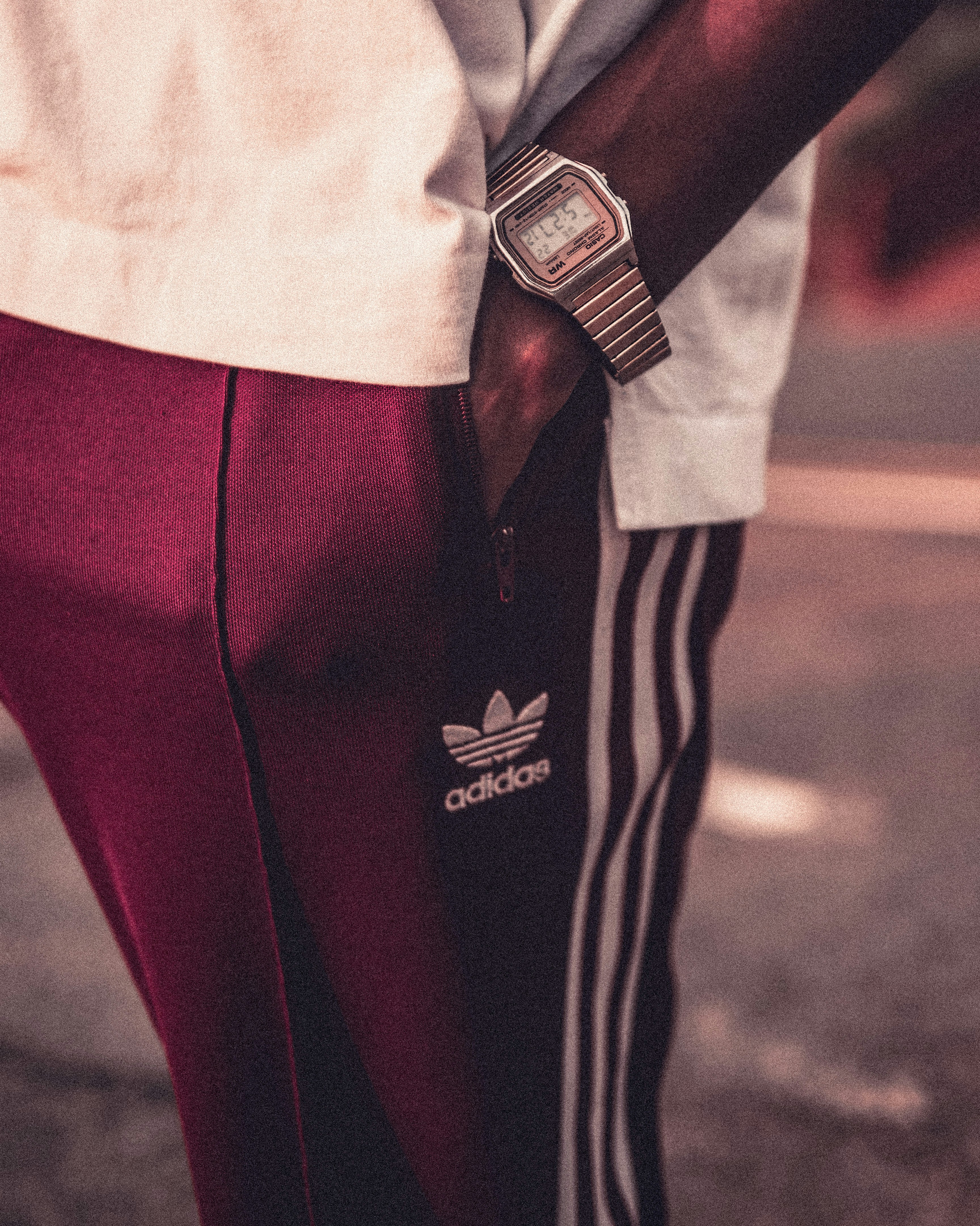 Timekeeping meets streetwear: burgundy joggers and a digital watch in focus