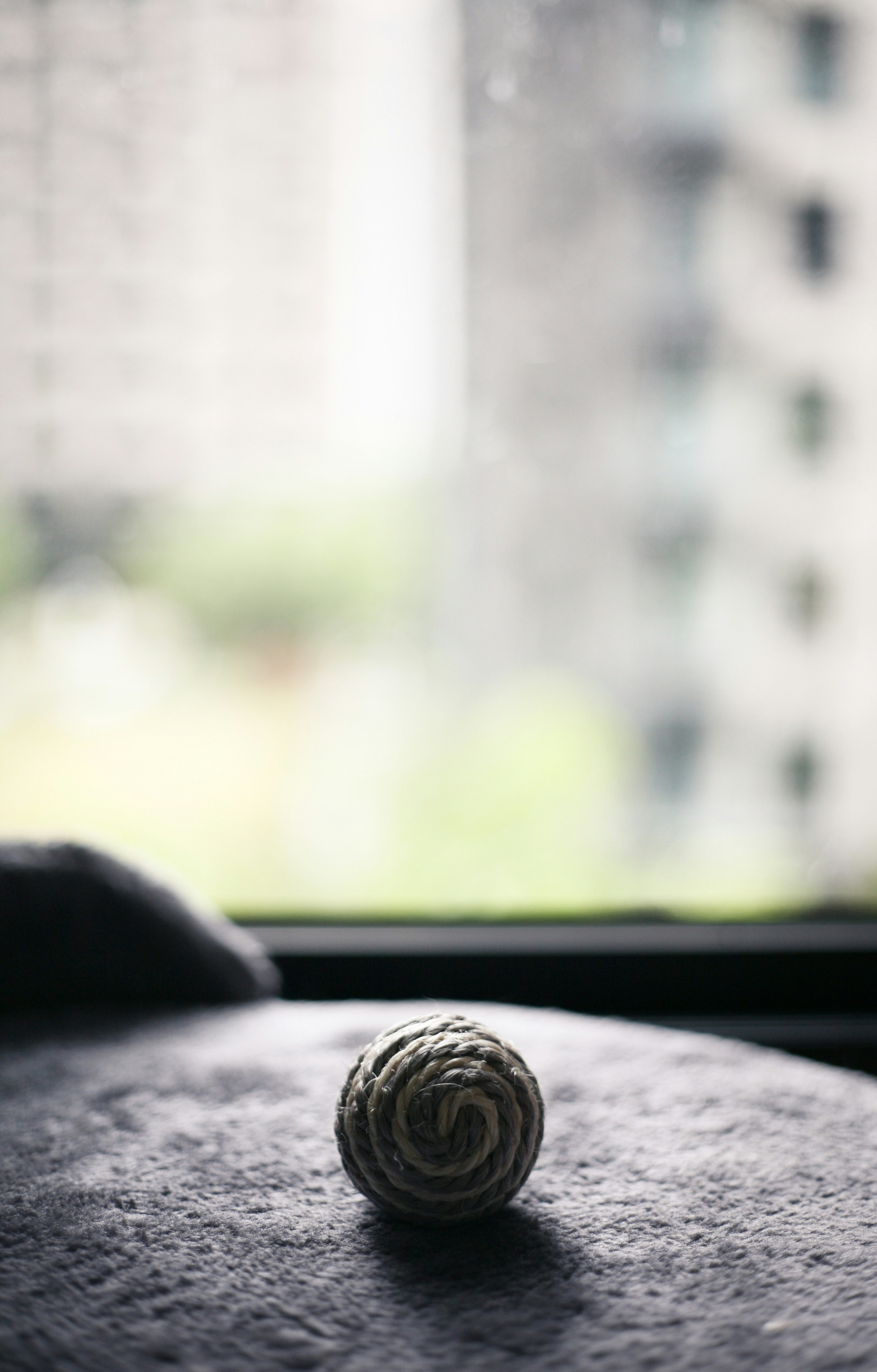 silver round coin on gray textile