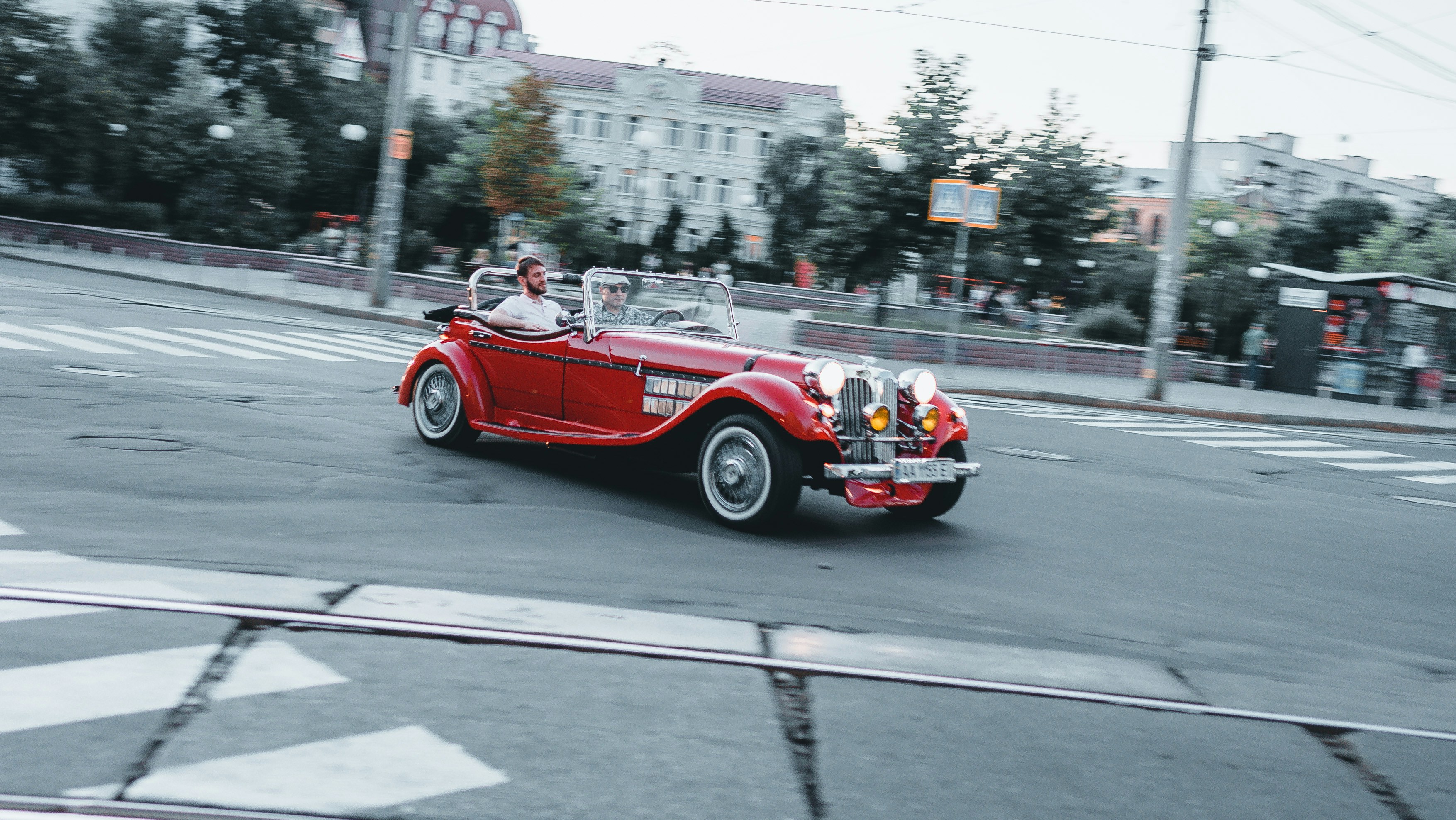 Vintage Red Roadster Crossing at the City Edge