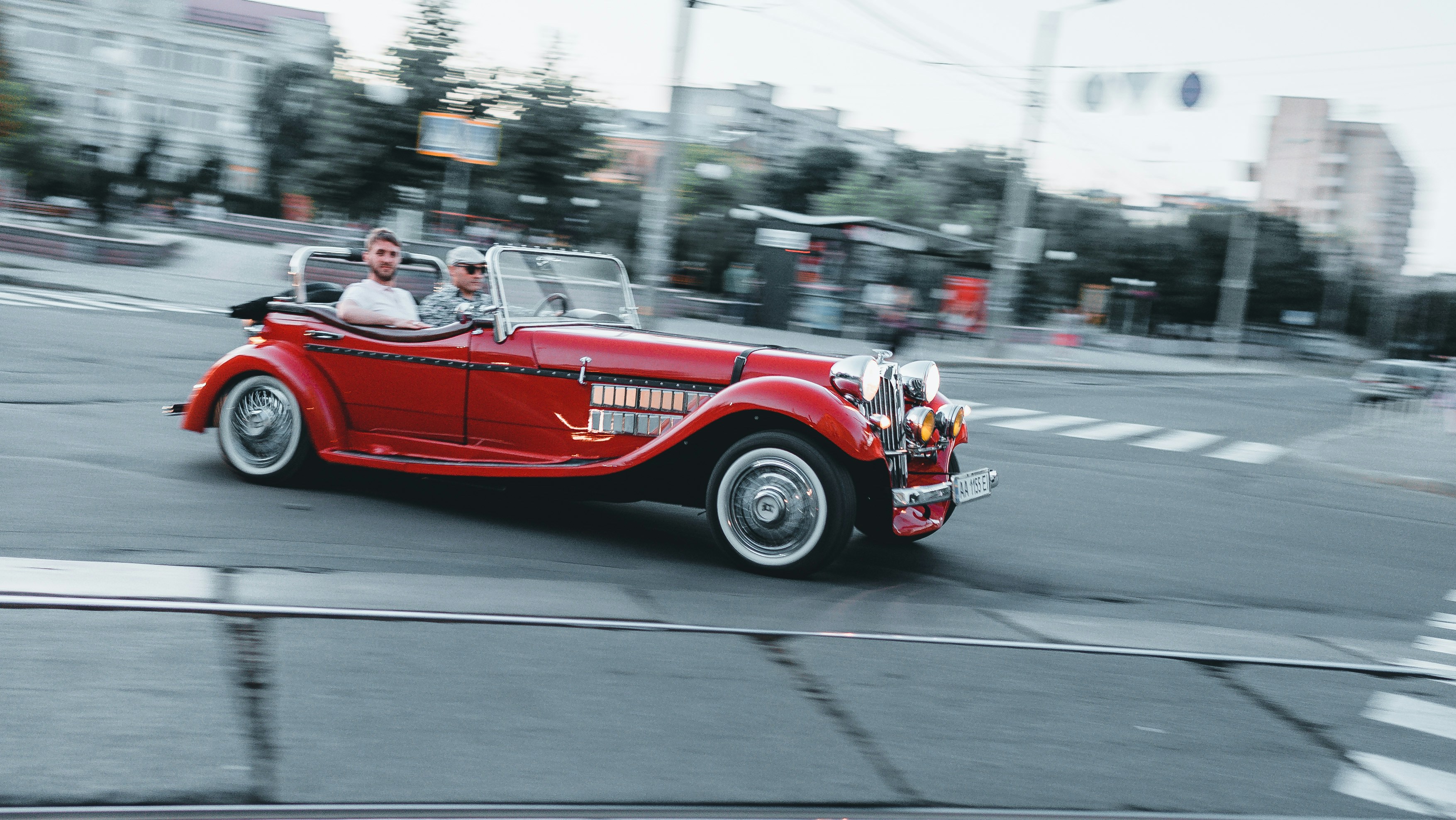 Red Convertible Smile: A Timeless Moment on City Streets