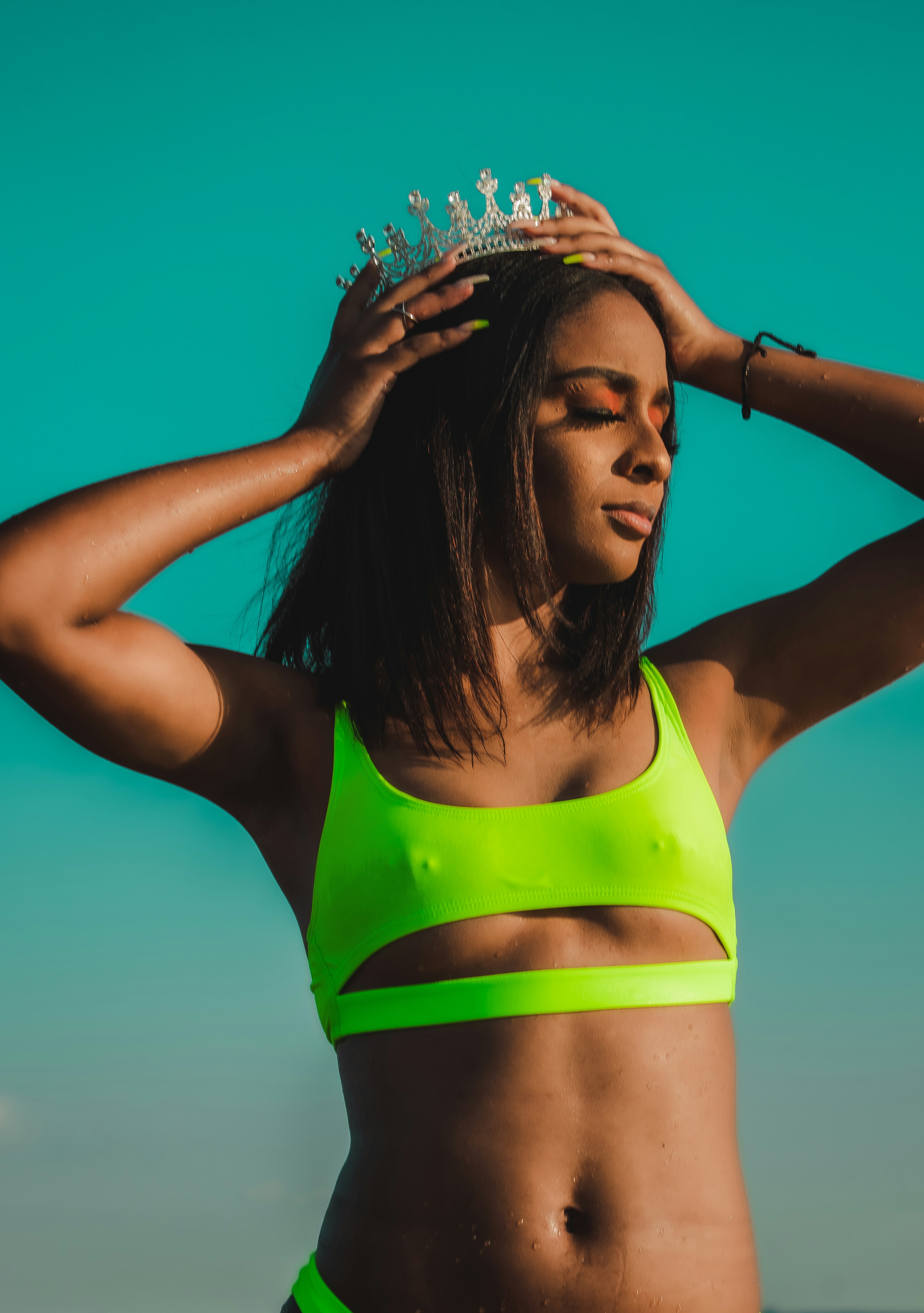 Crown of sun: A neon-green silhouette under a teal sky