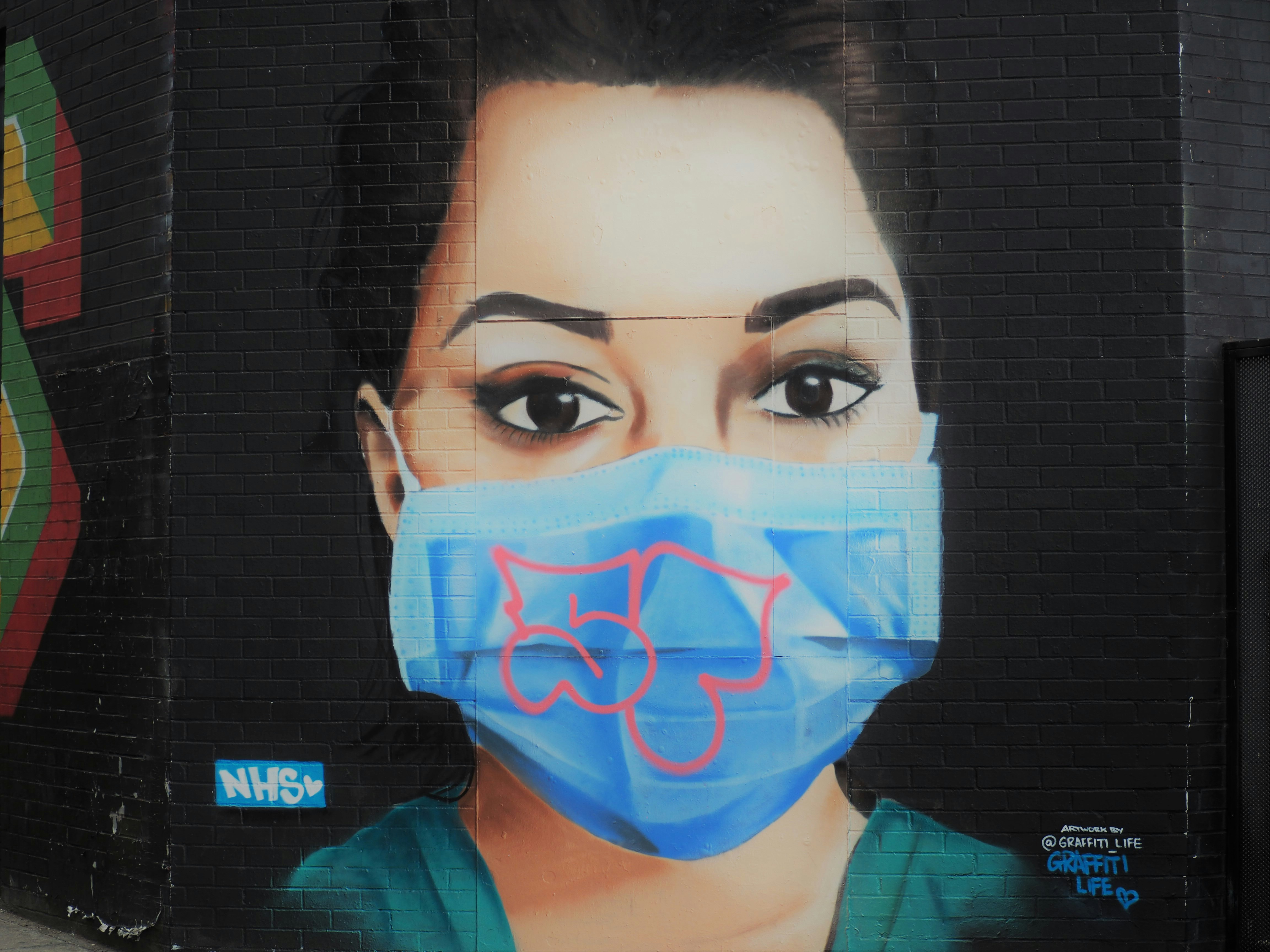 Masked Portrait: City Wall, Bright Blue Mask Draped Across a Compute‑Human Face