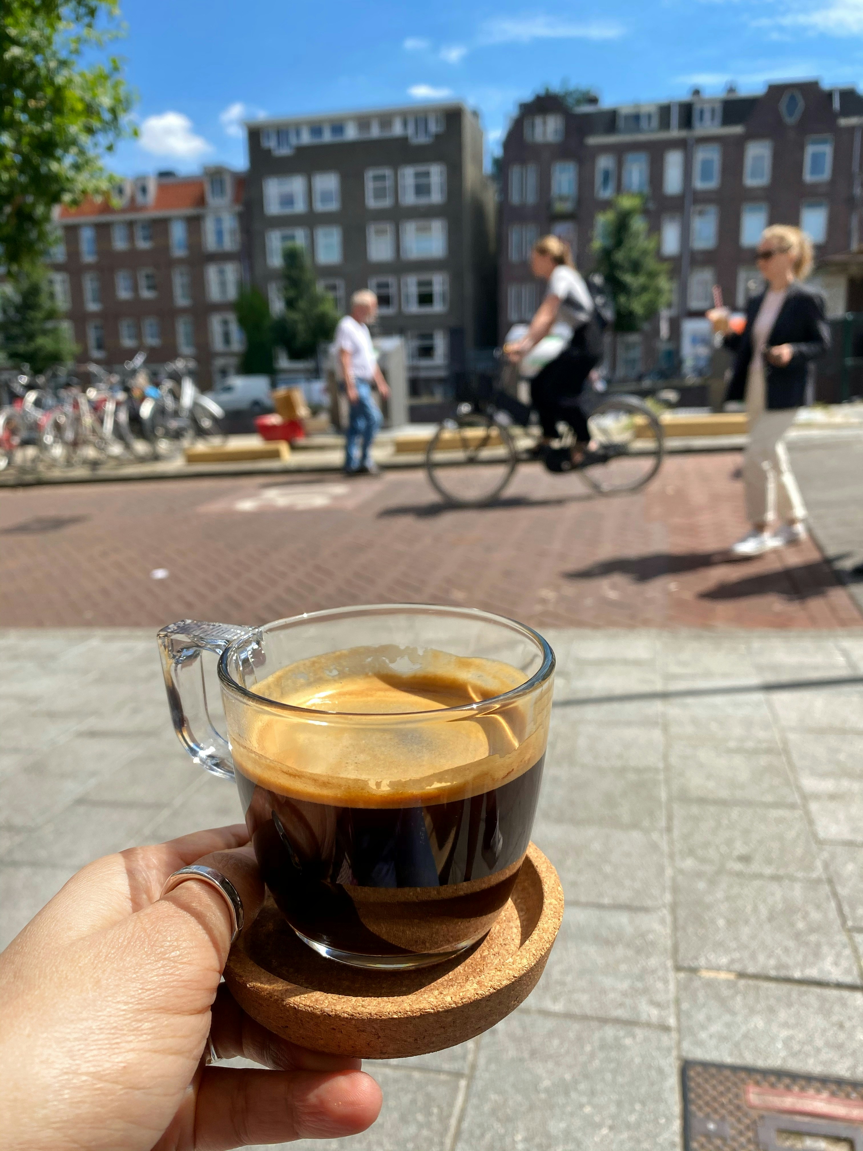Coffee in Amsterdam. Coffee cup, espresso. Biking in Amsterdam. Summer. Spring. 