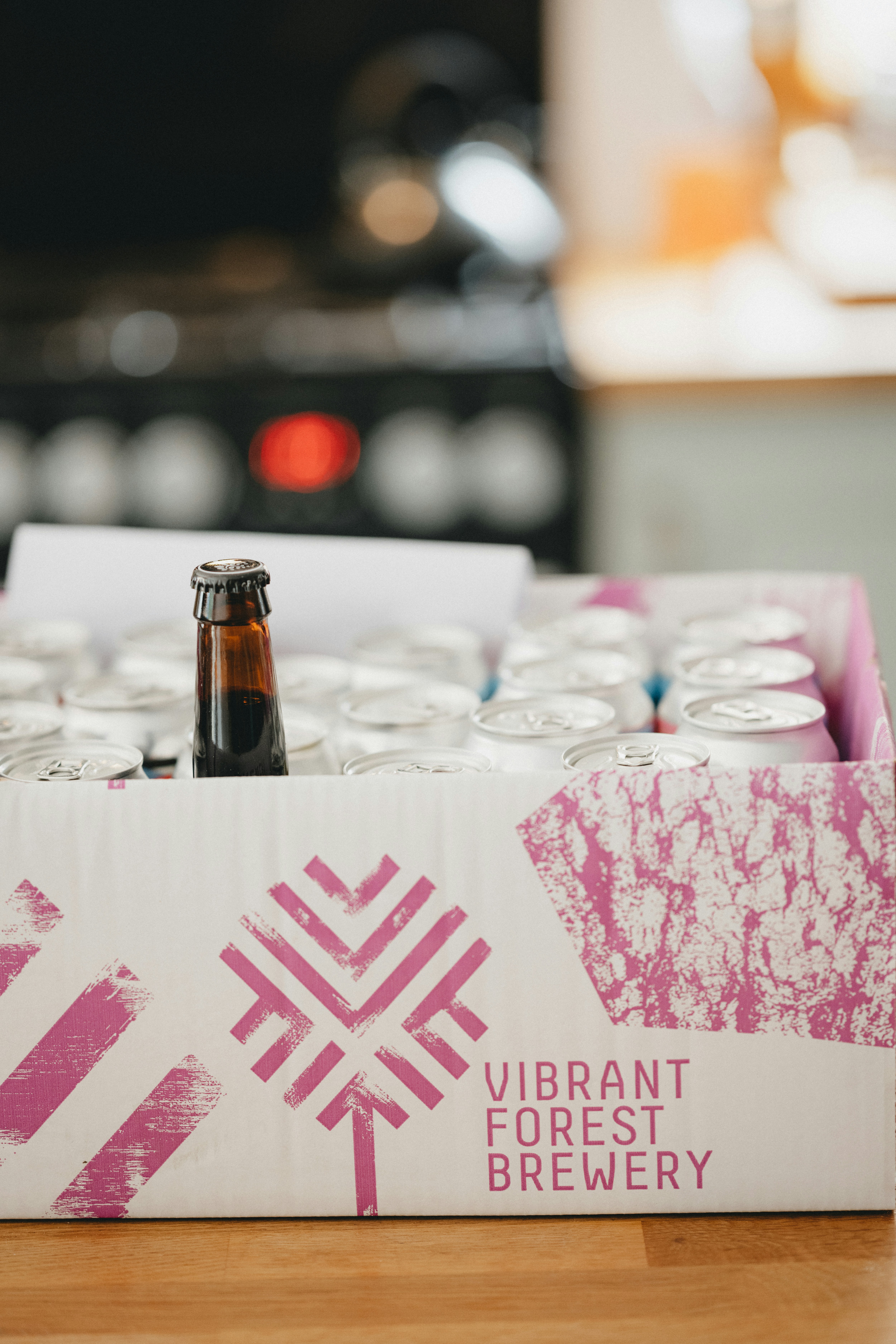 brown glass bottle on white and pink hearts print textile