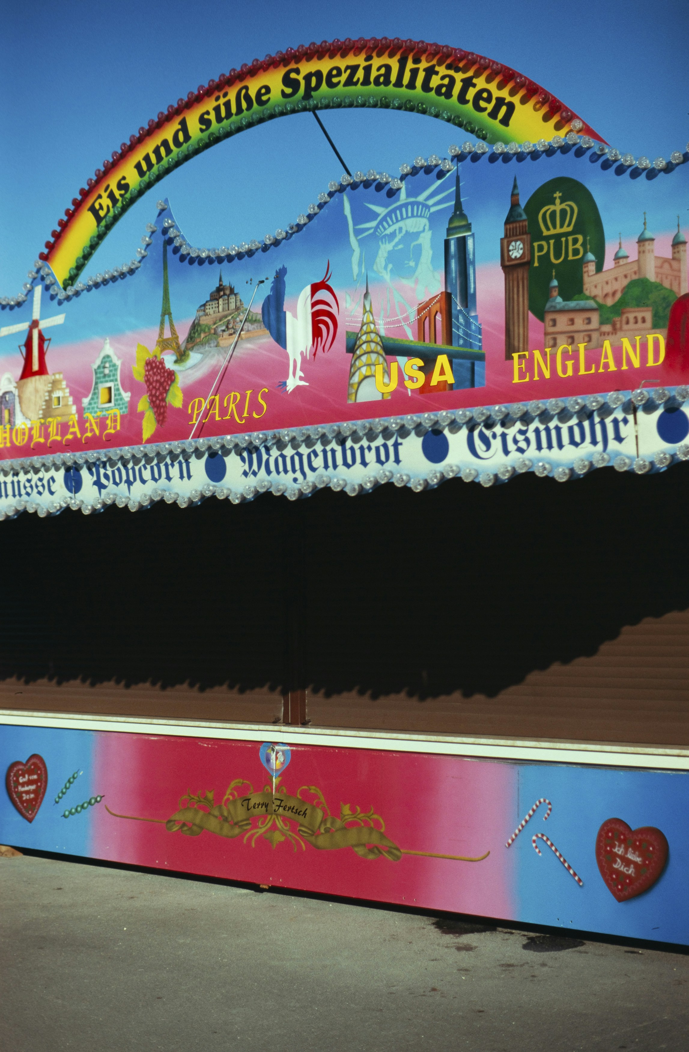 Rainbow Arch Over a World of Icons at a Fairground