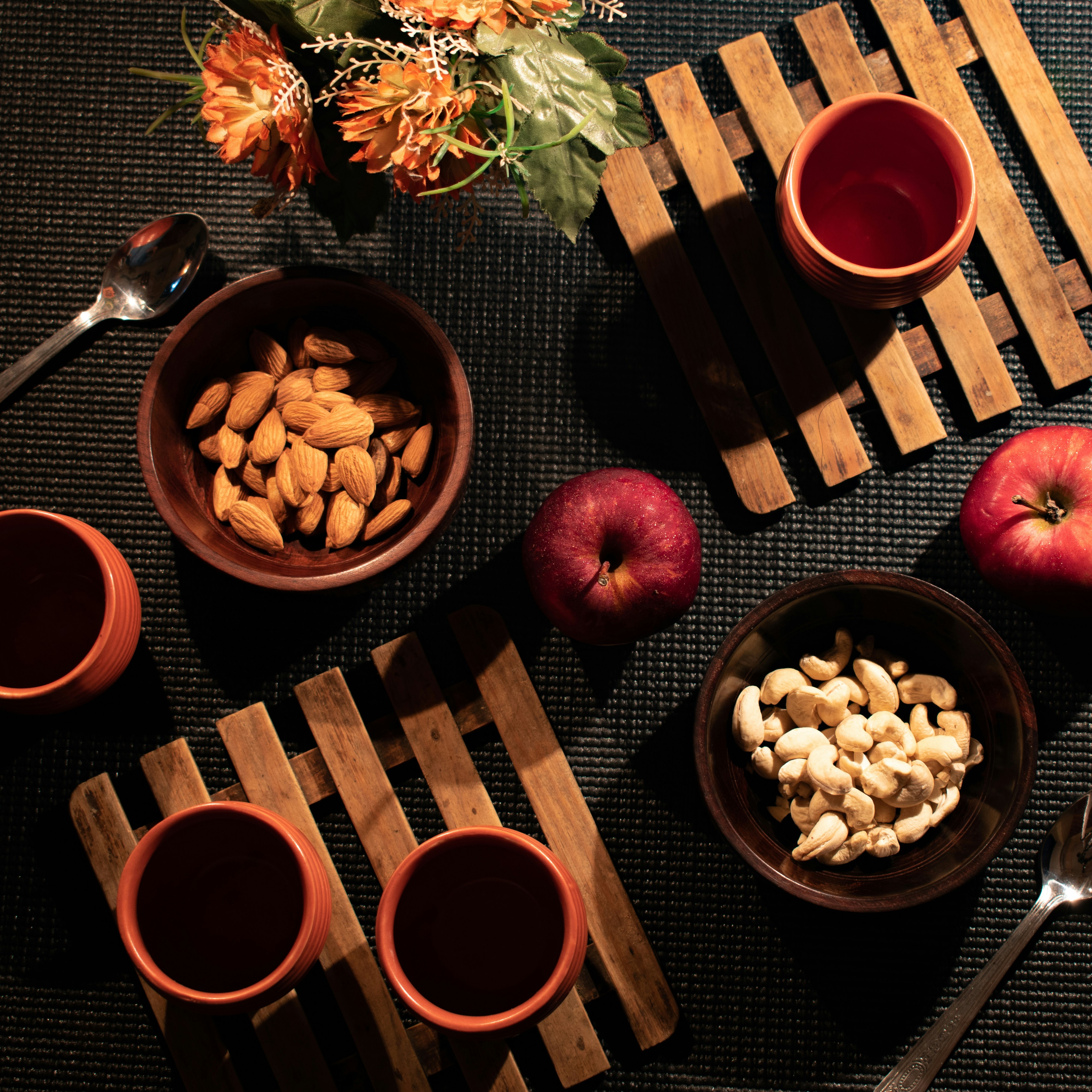 Amber Nuts and Red Apples: A Cozy Still-Life on Dark Textures