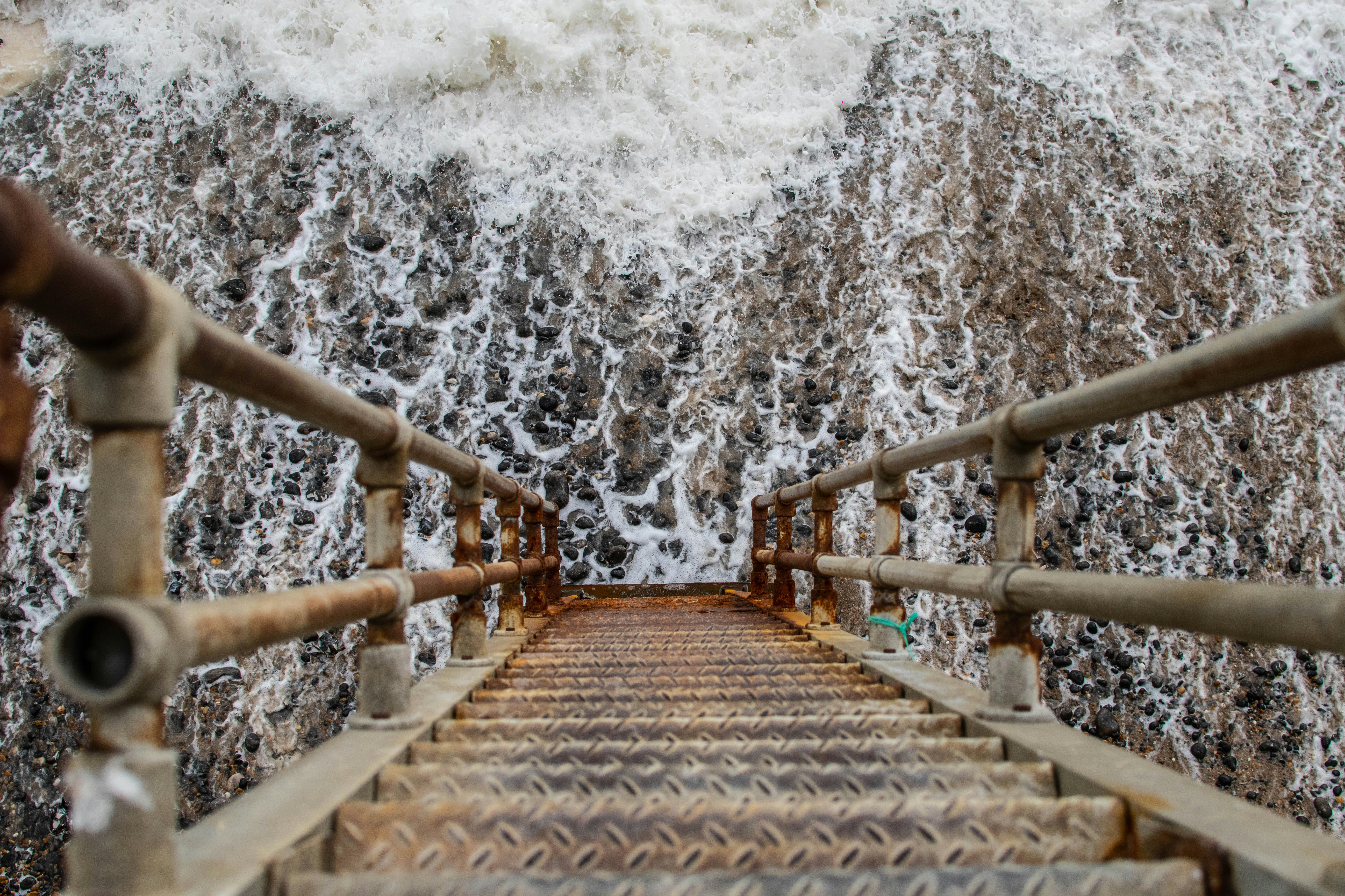 Stairway to the Foam Edge: A Weathered Descent Over Churning Water