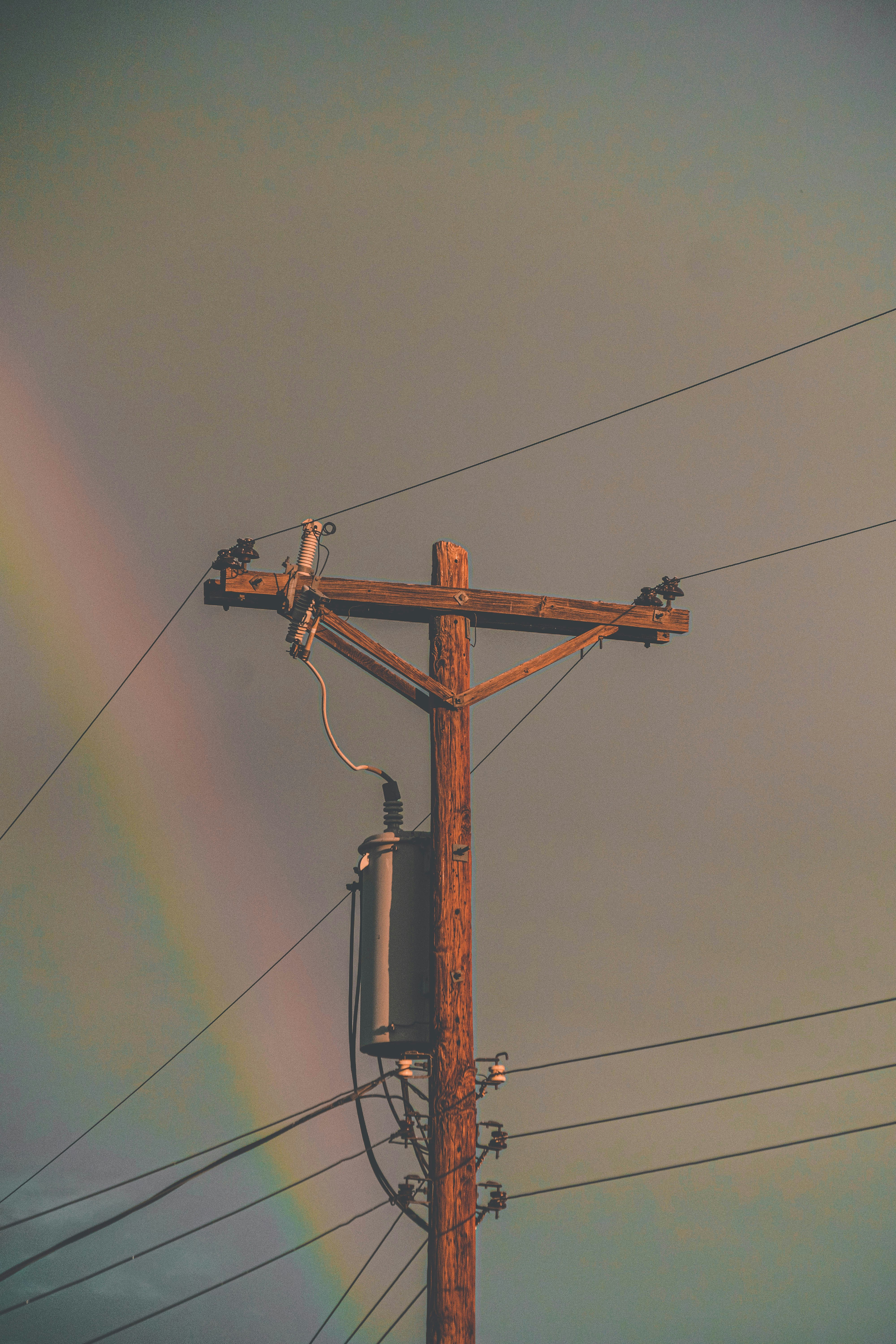 Double Rainbow Over a Weathered Utility Pole