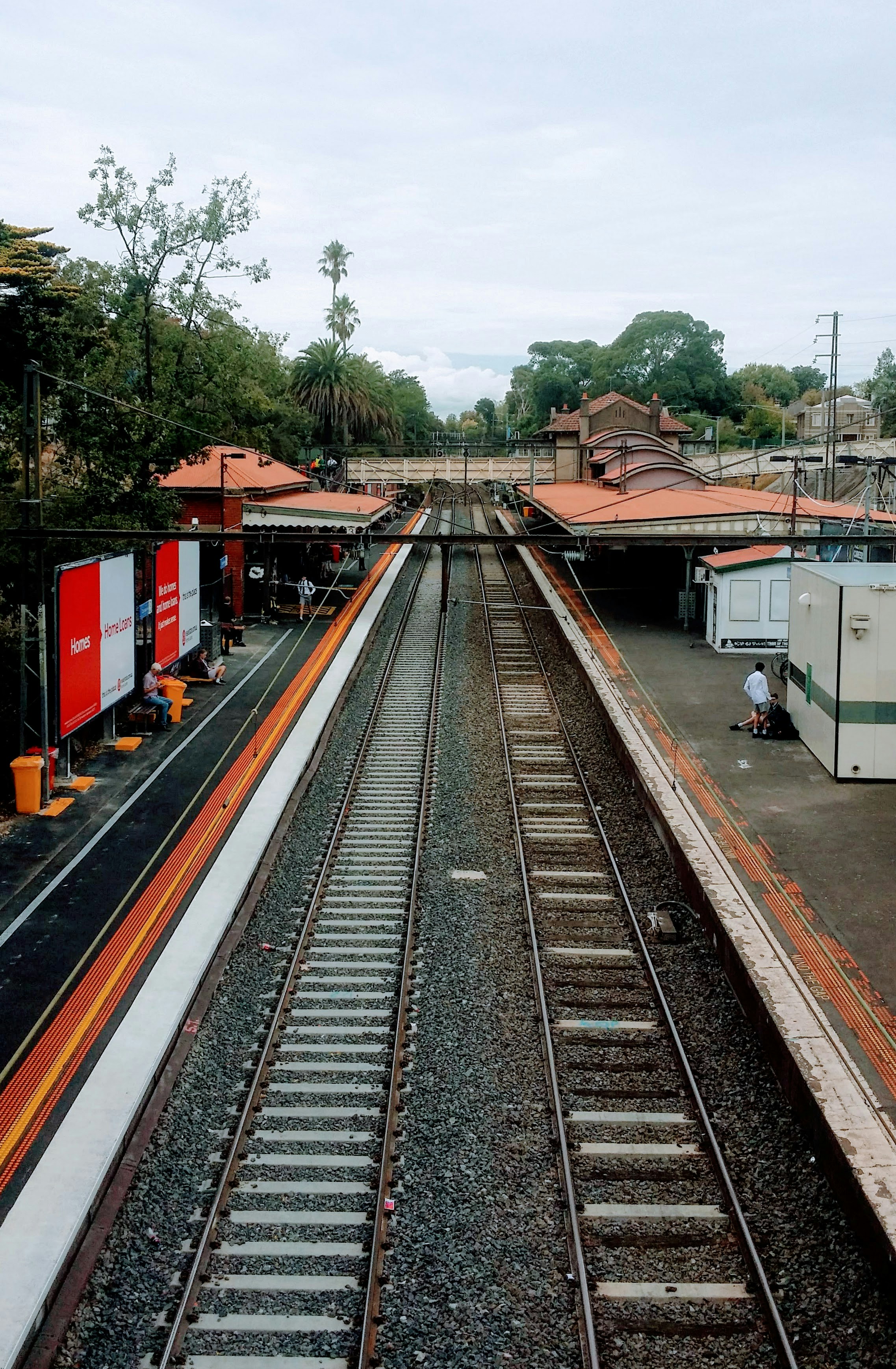 Convergence at the Platform: Rails Vanishing Toward the Station's Horizon