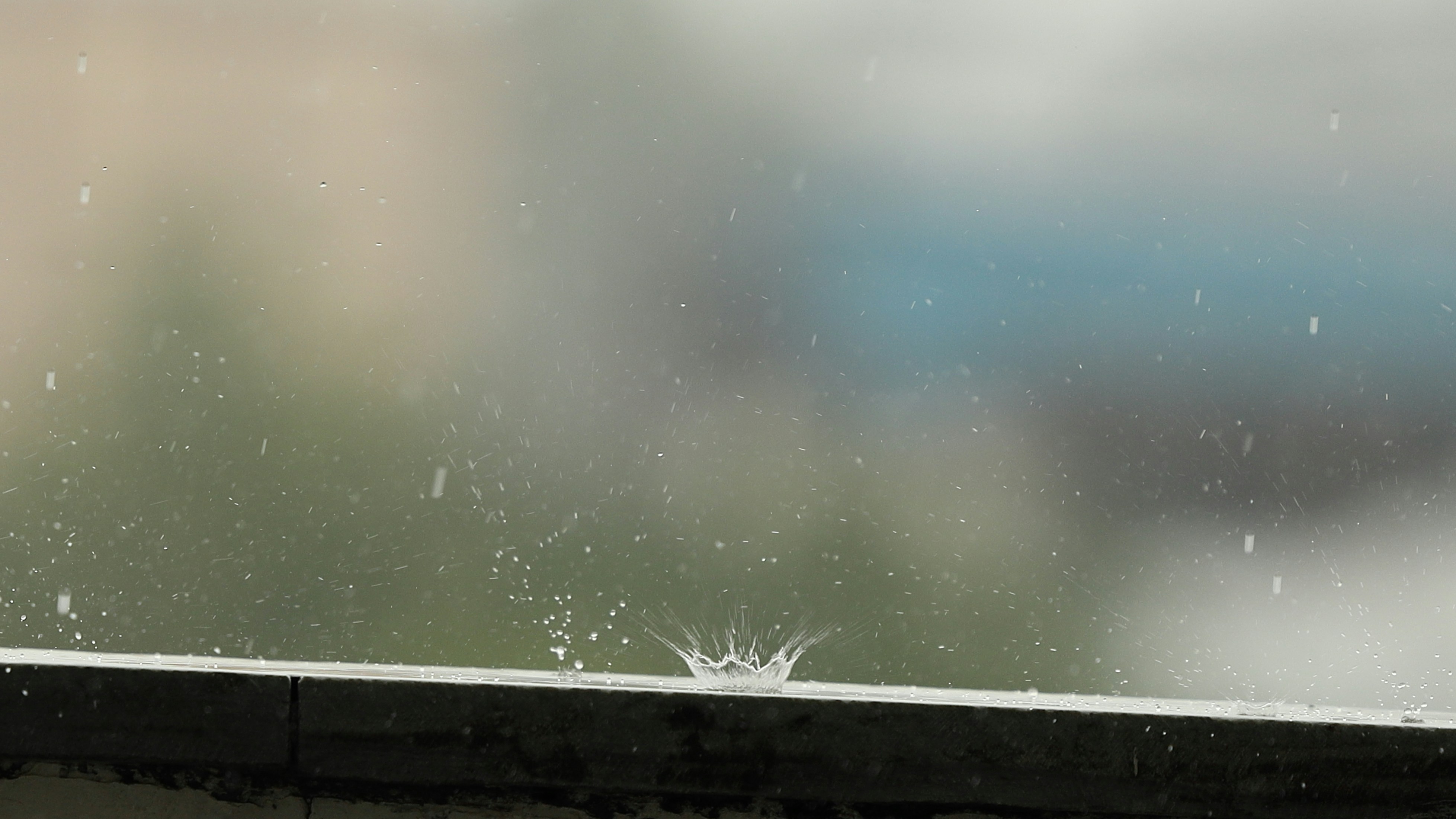 Rain-splashed Window Crown: A Single Droplet Burst at Dusk