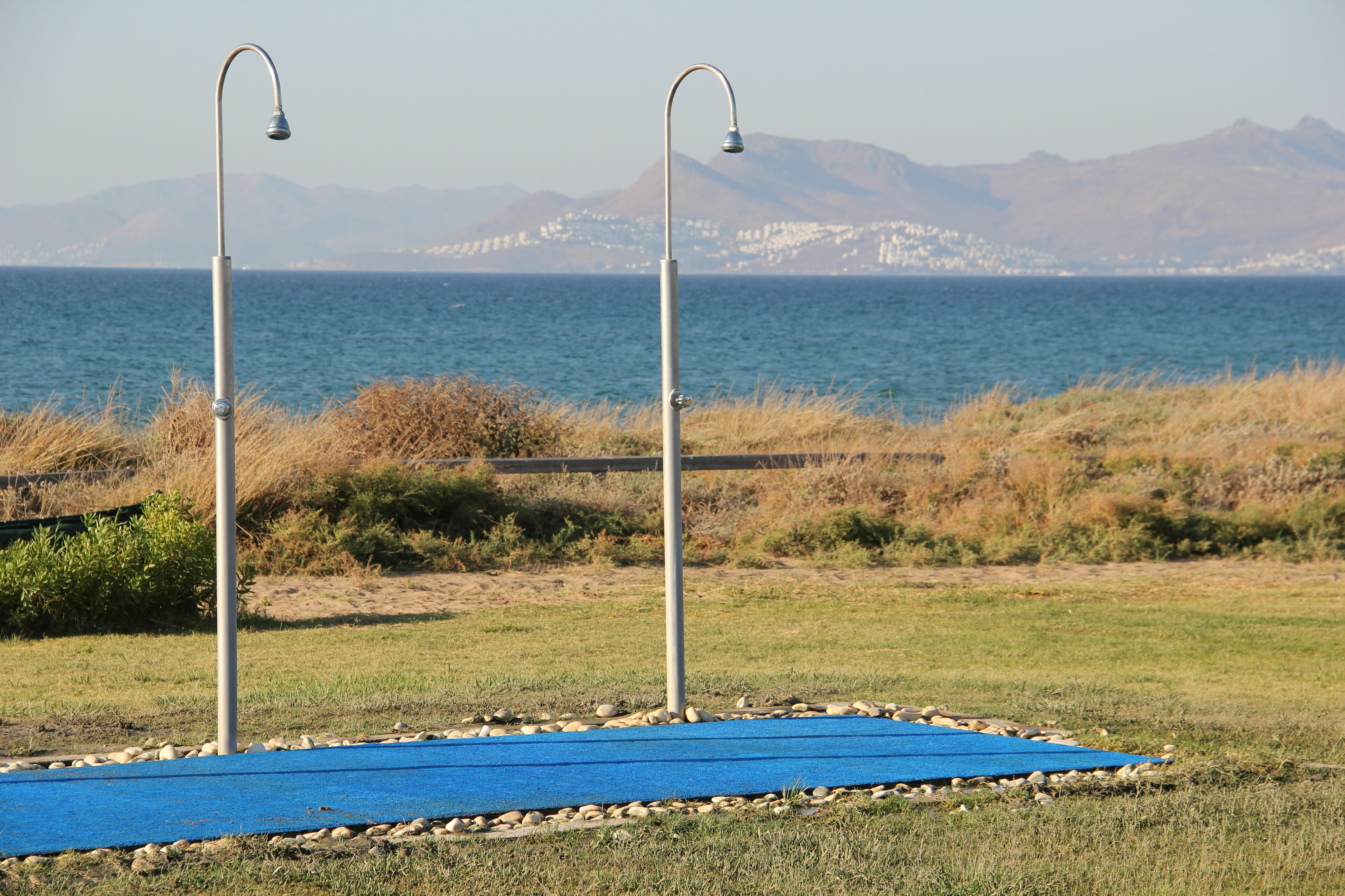 blue and white swimming pool near green grass field during daytime