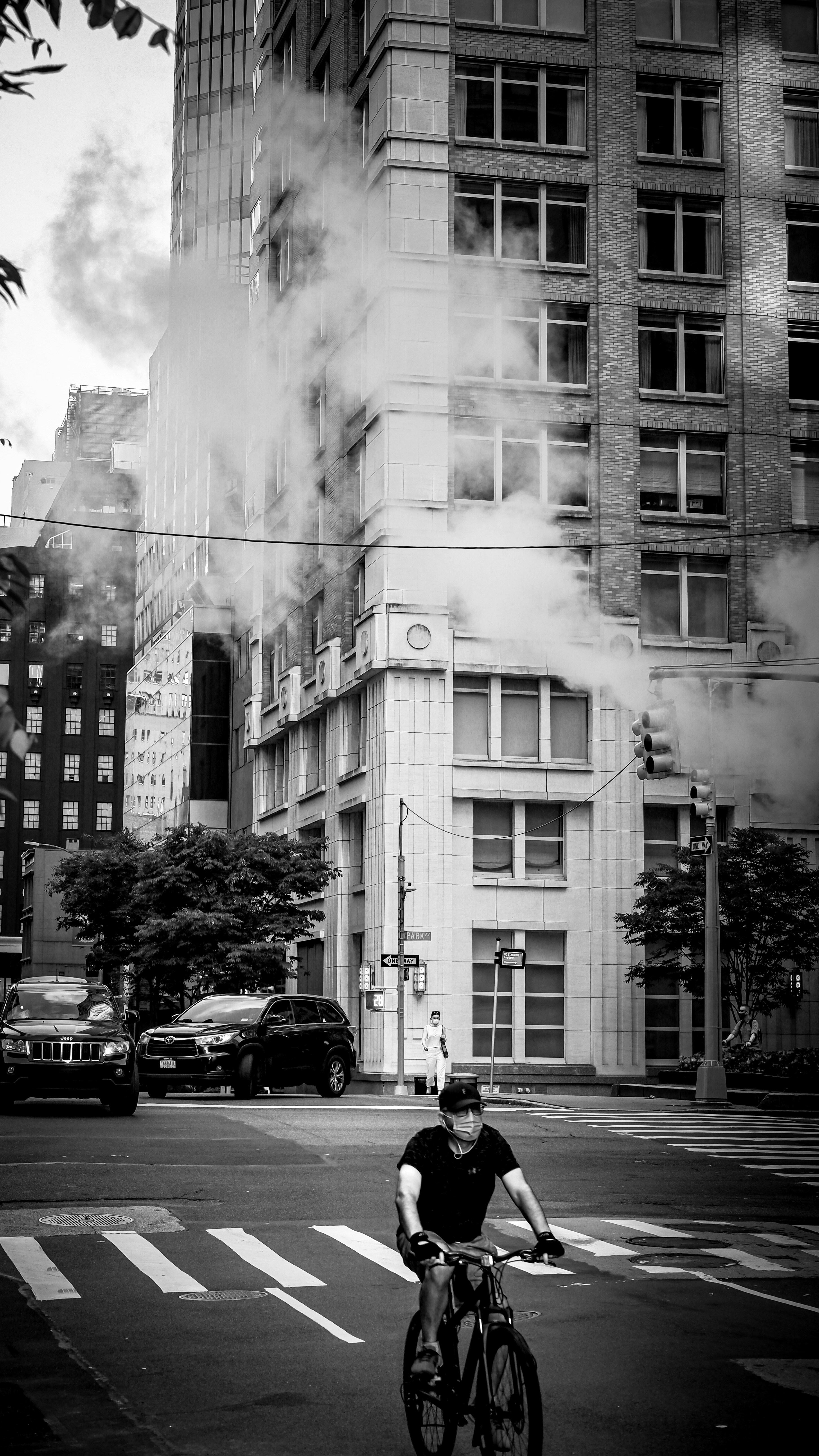 Crossroads in Steam: A Cyclist Against a Monochrome Skyline