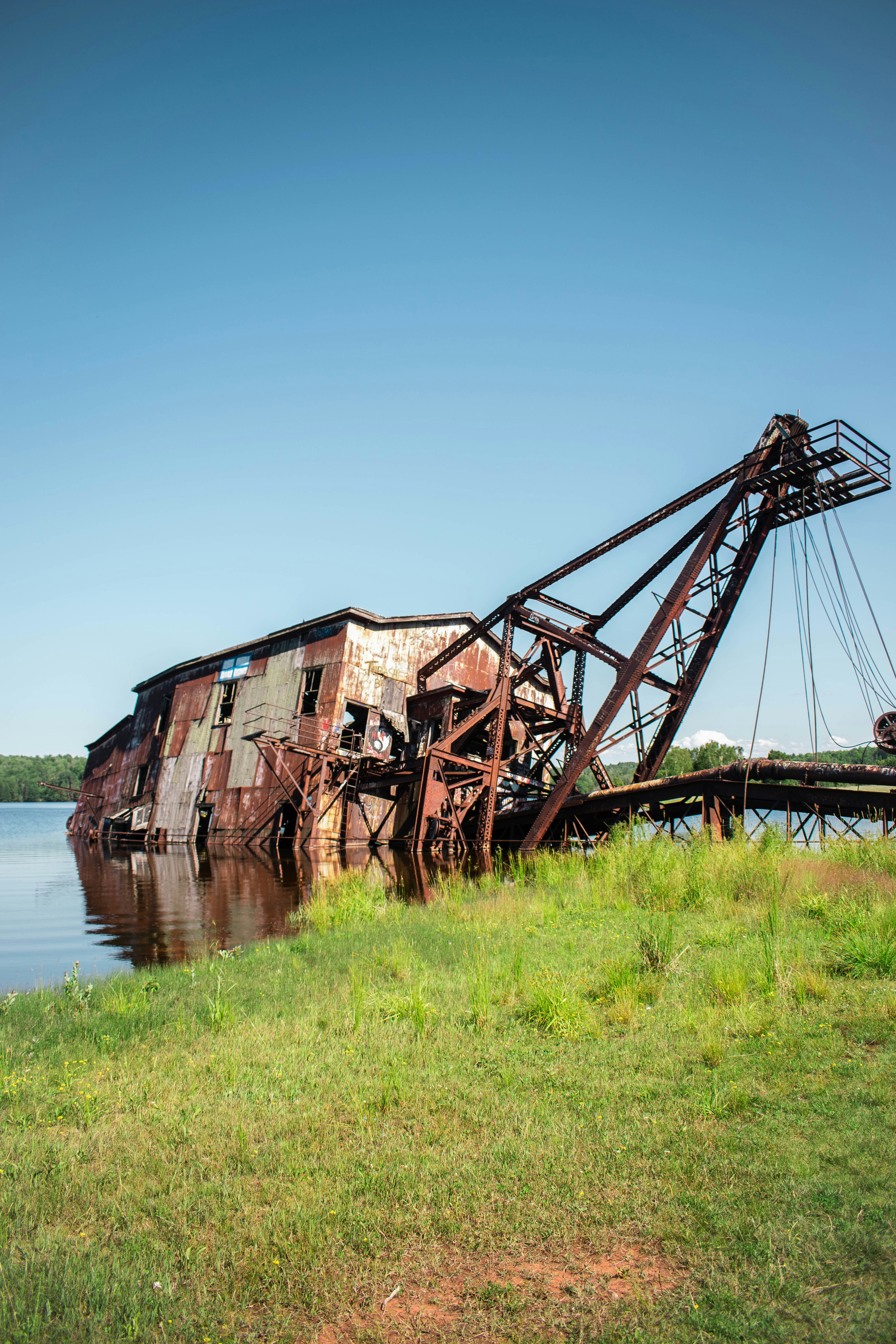 Rust and Reflection: The Weathered Crane at the Waterline
