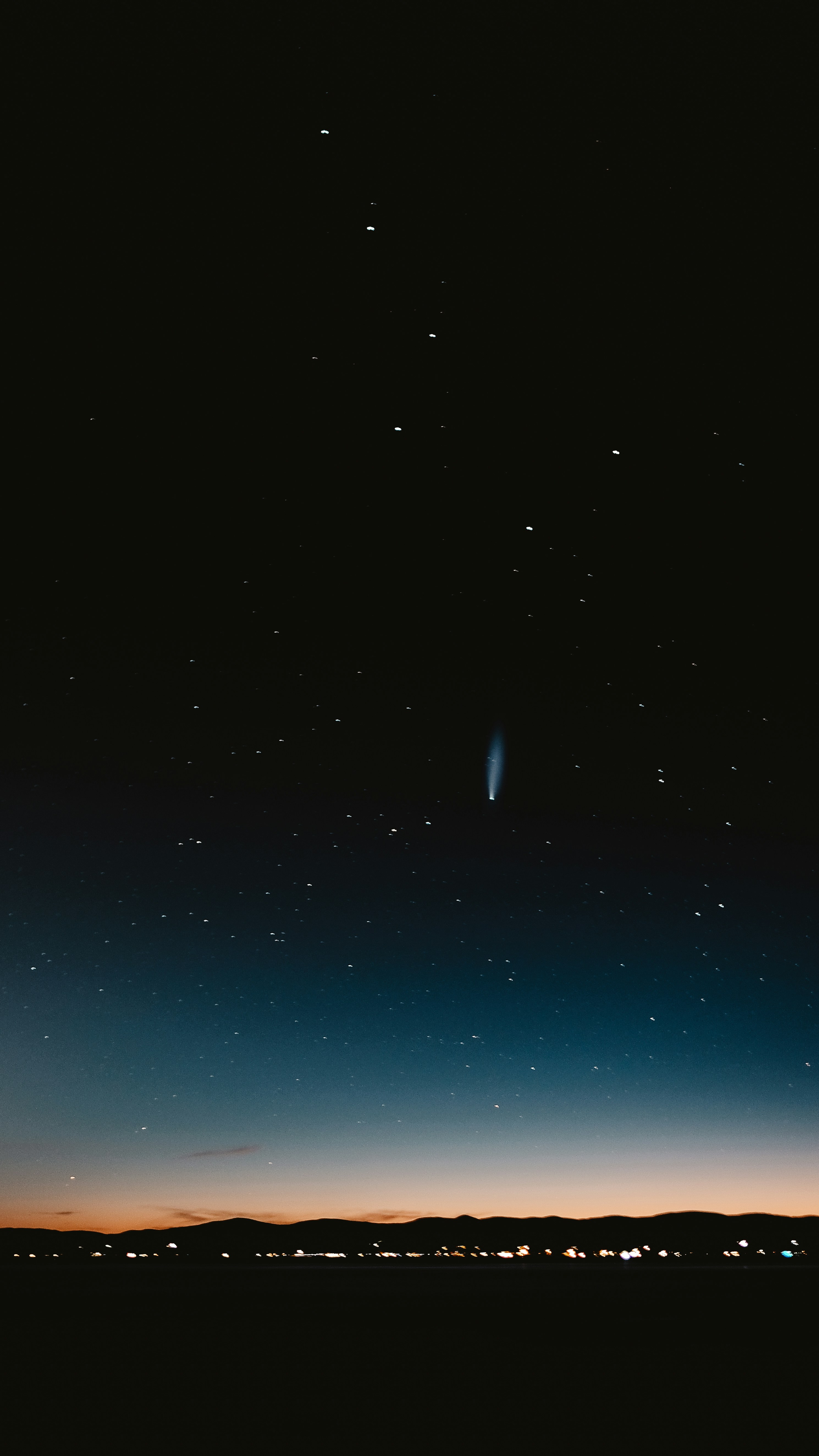 Blue Meteor Traverses a Starry Dusk Above a Quiet Horizon