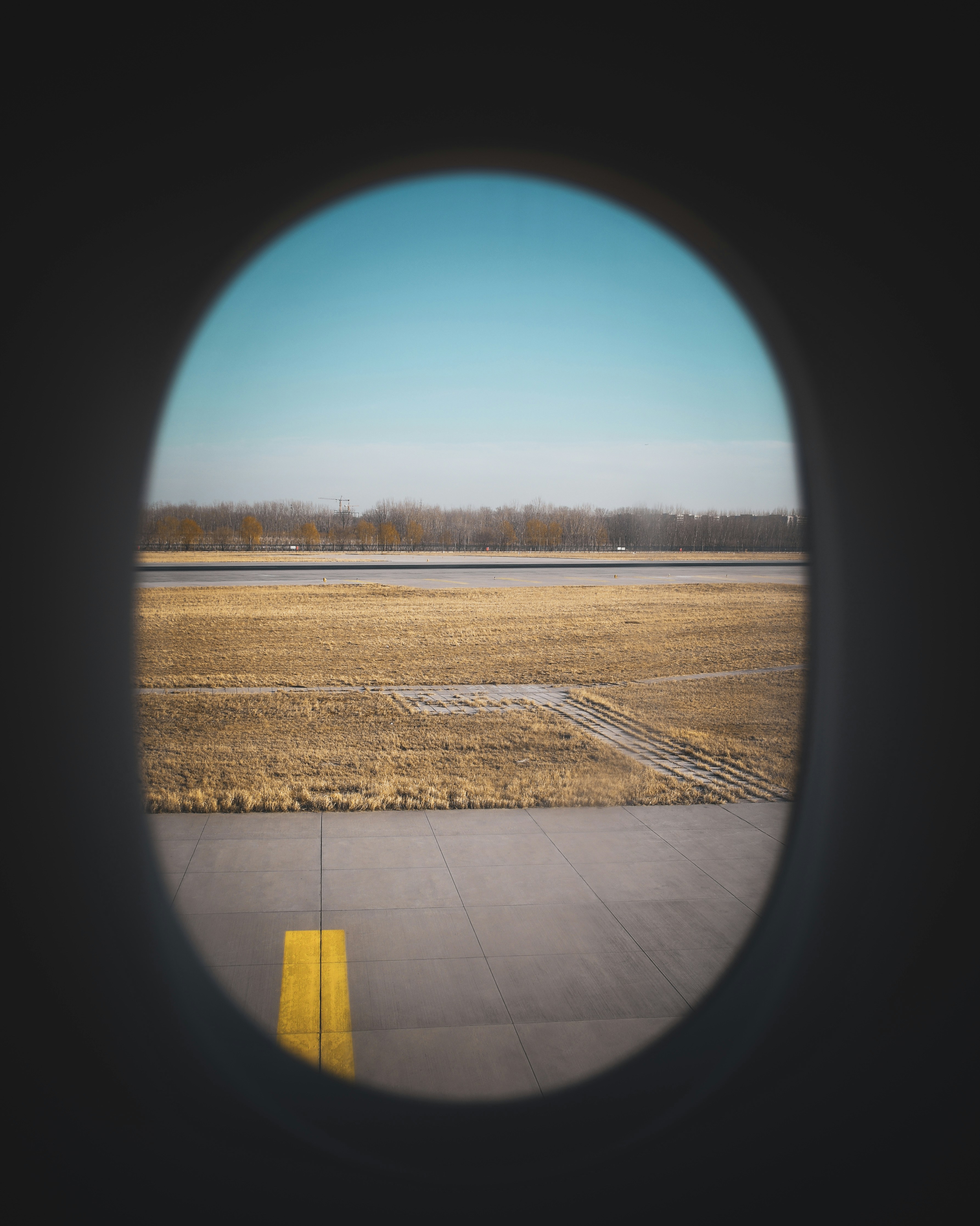 Horizon Framed by the Window: A Quiet Runway Over Winter Fields