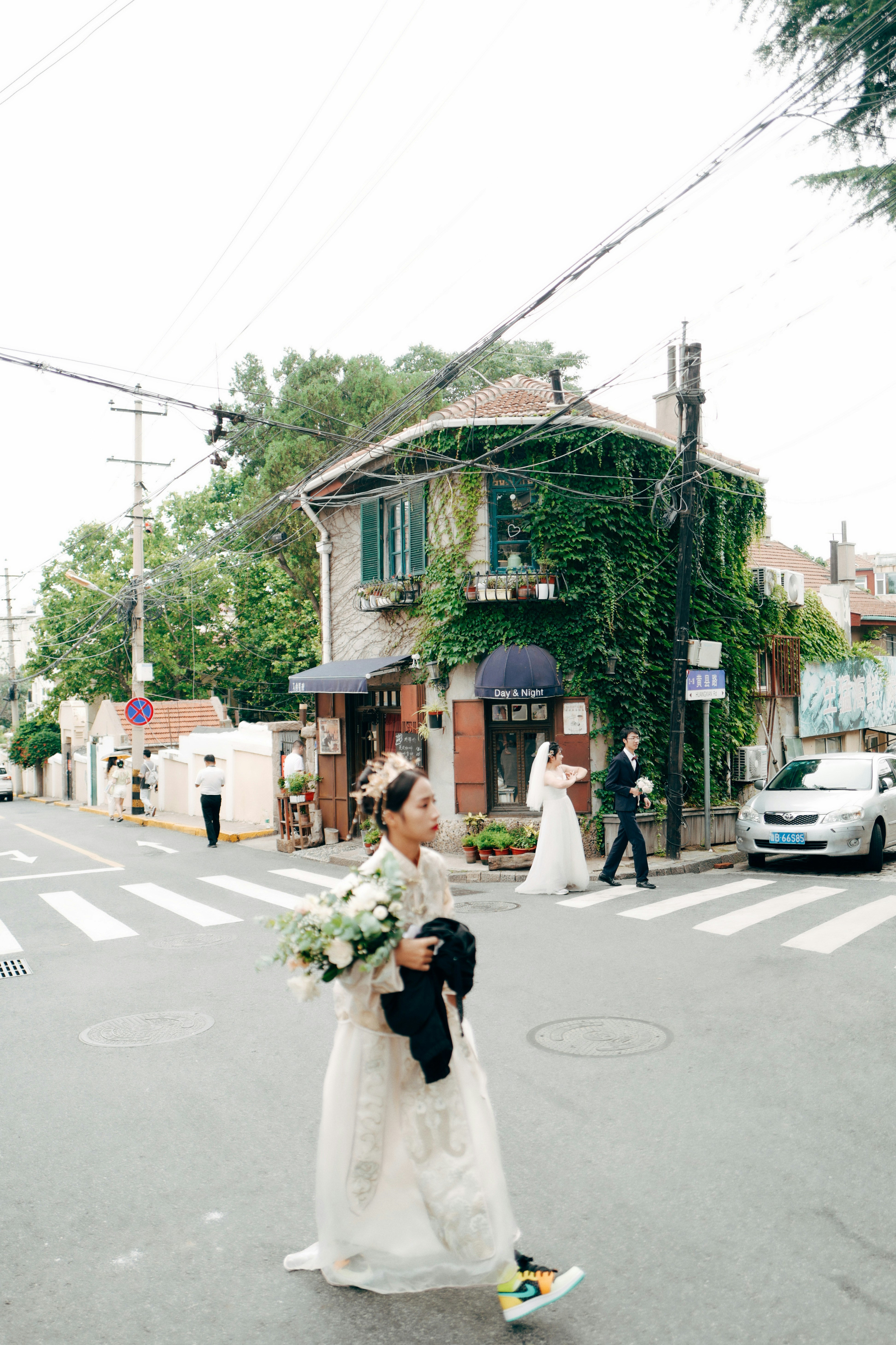 Ivy-Covered Crosswalk: A Bride Carries Her Bouquet Through a Quiet City Street