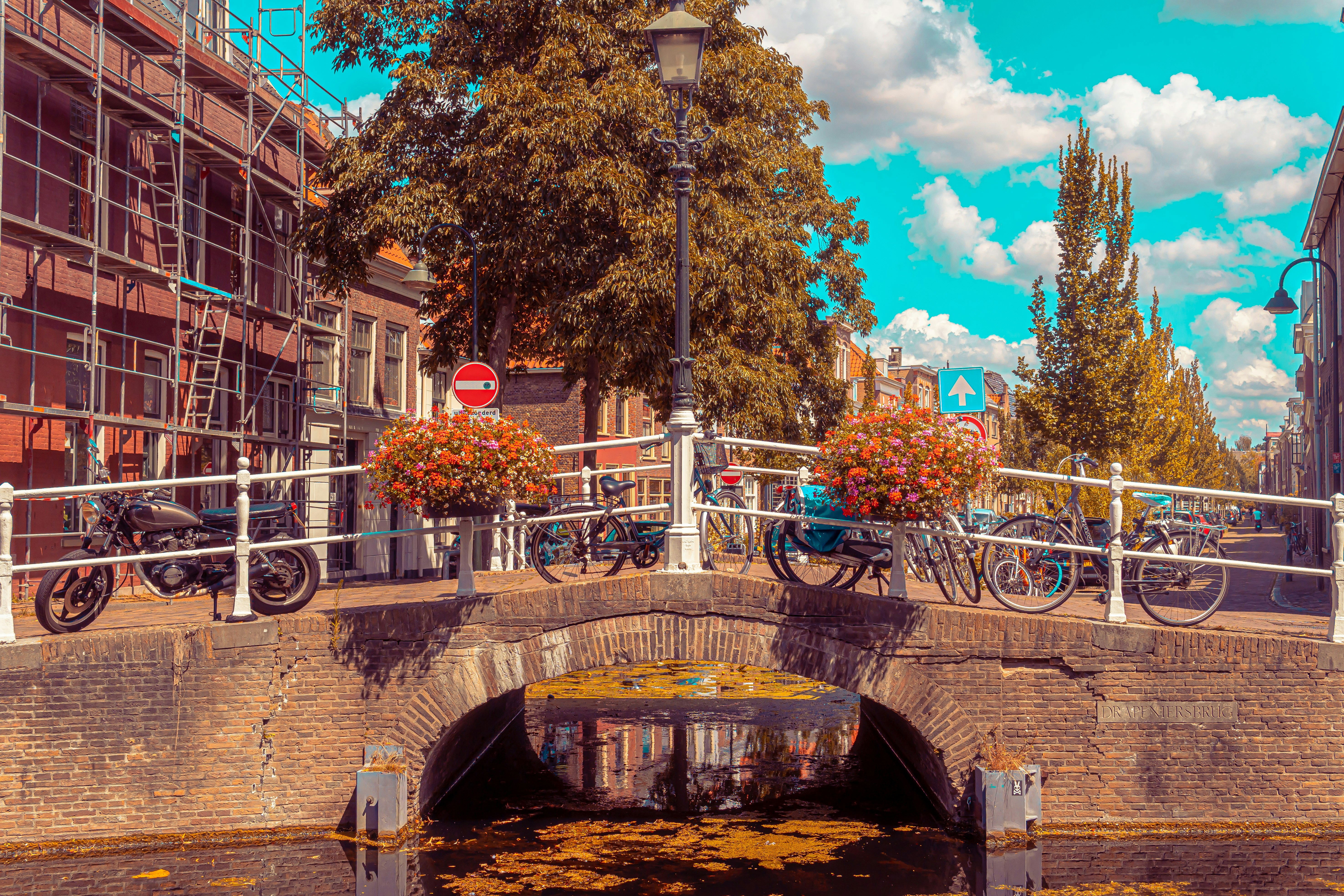 Brown concrete bridge over river photo – Free Delft Image on Unsplash