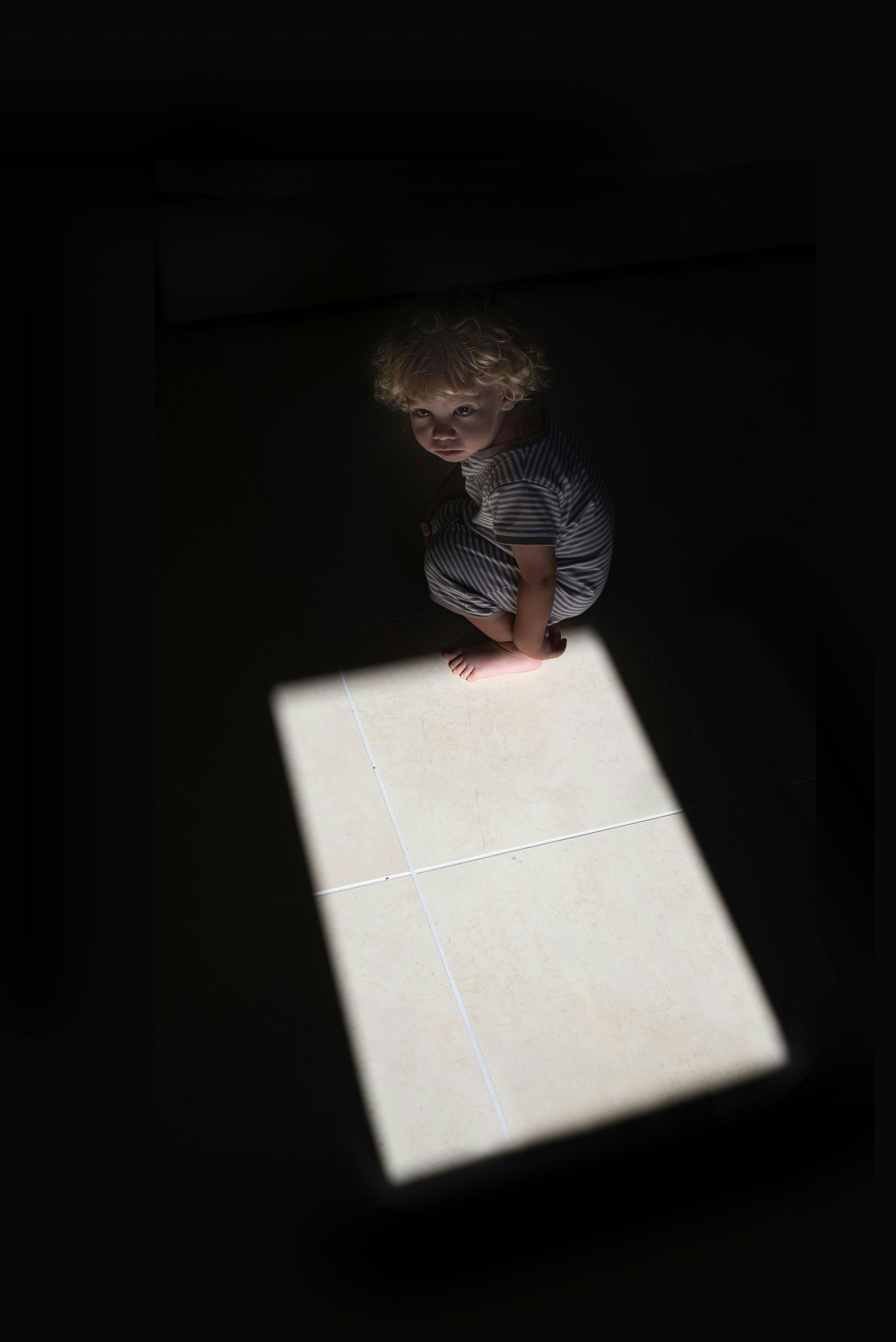 Child at the Doorway: A Sliver of Light