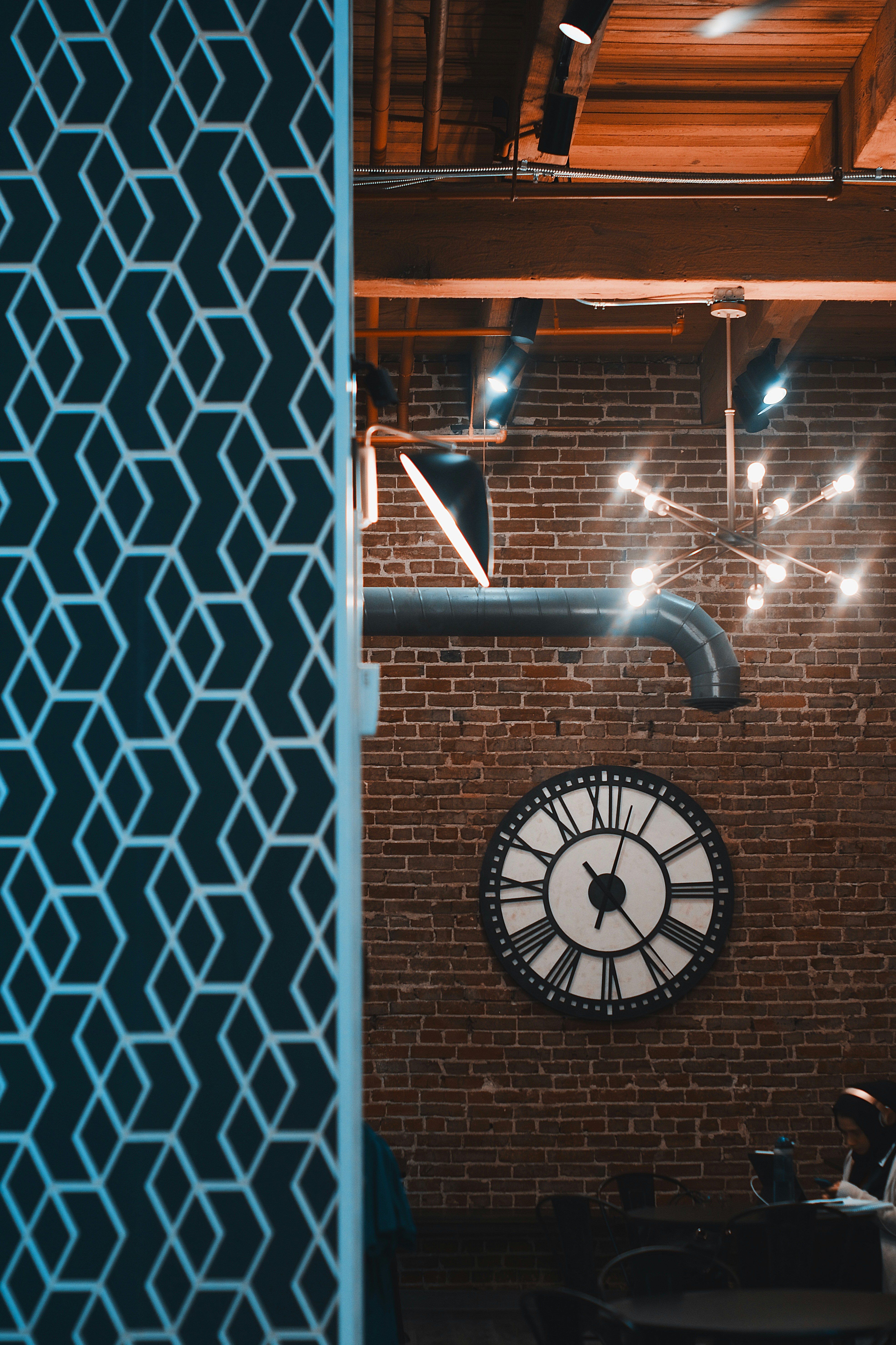 Industrial Clockroom: Brick Wall and Oversized Dial Amid Exposed Piping